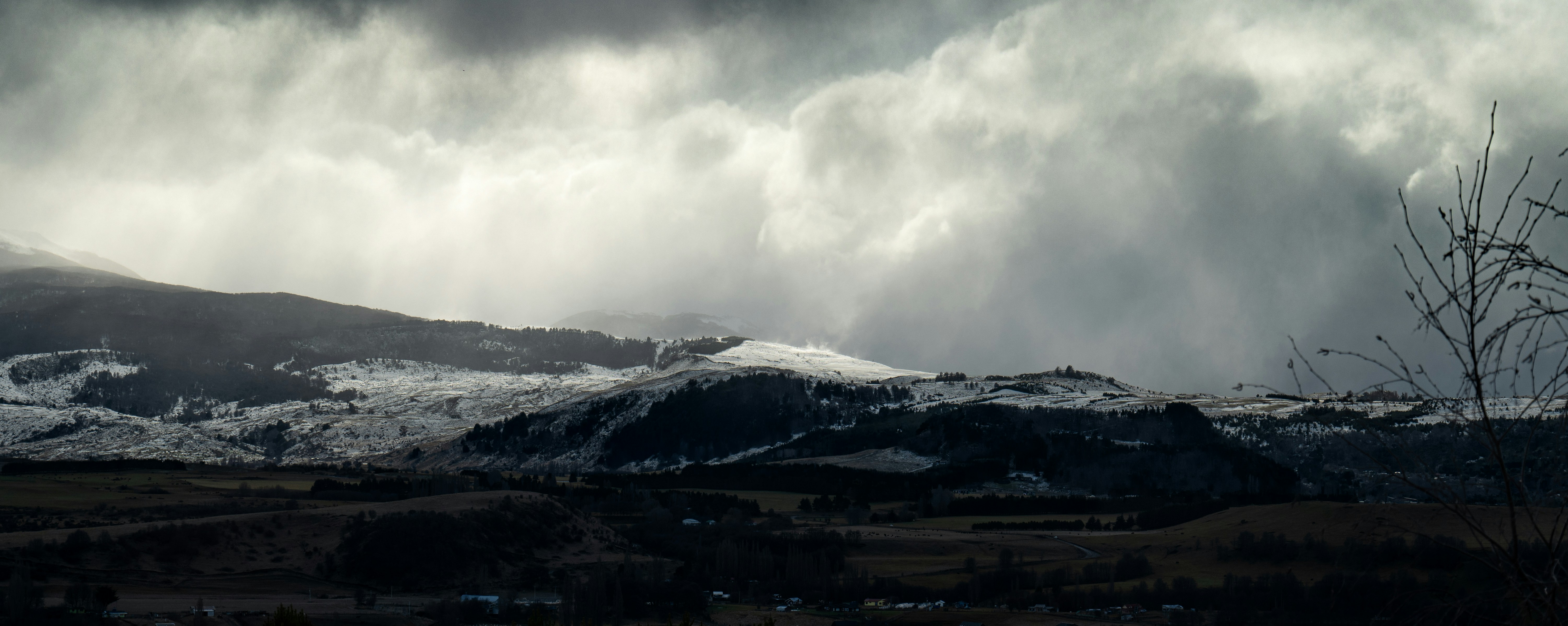 Storm-Driven Ridge: Snow-Draped Hills Under Breaks in the Clouds