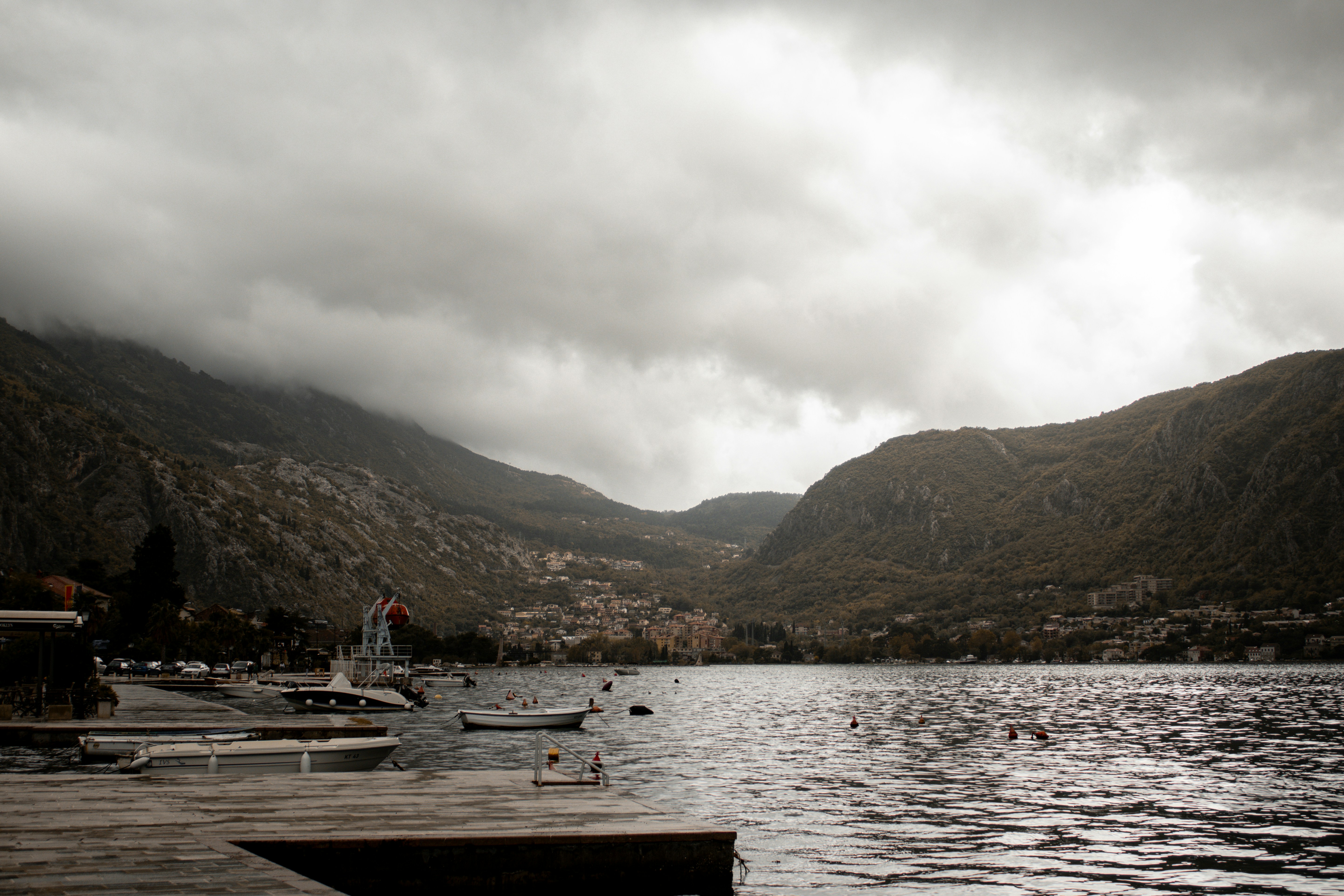 Dockside Quiet: Boats Rest at the Edge of a Mist-Shrouded Mountain Lake