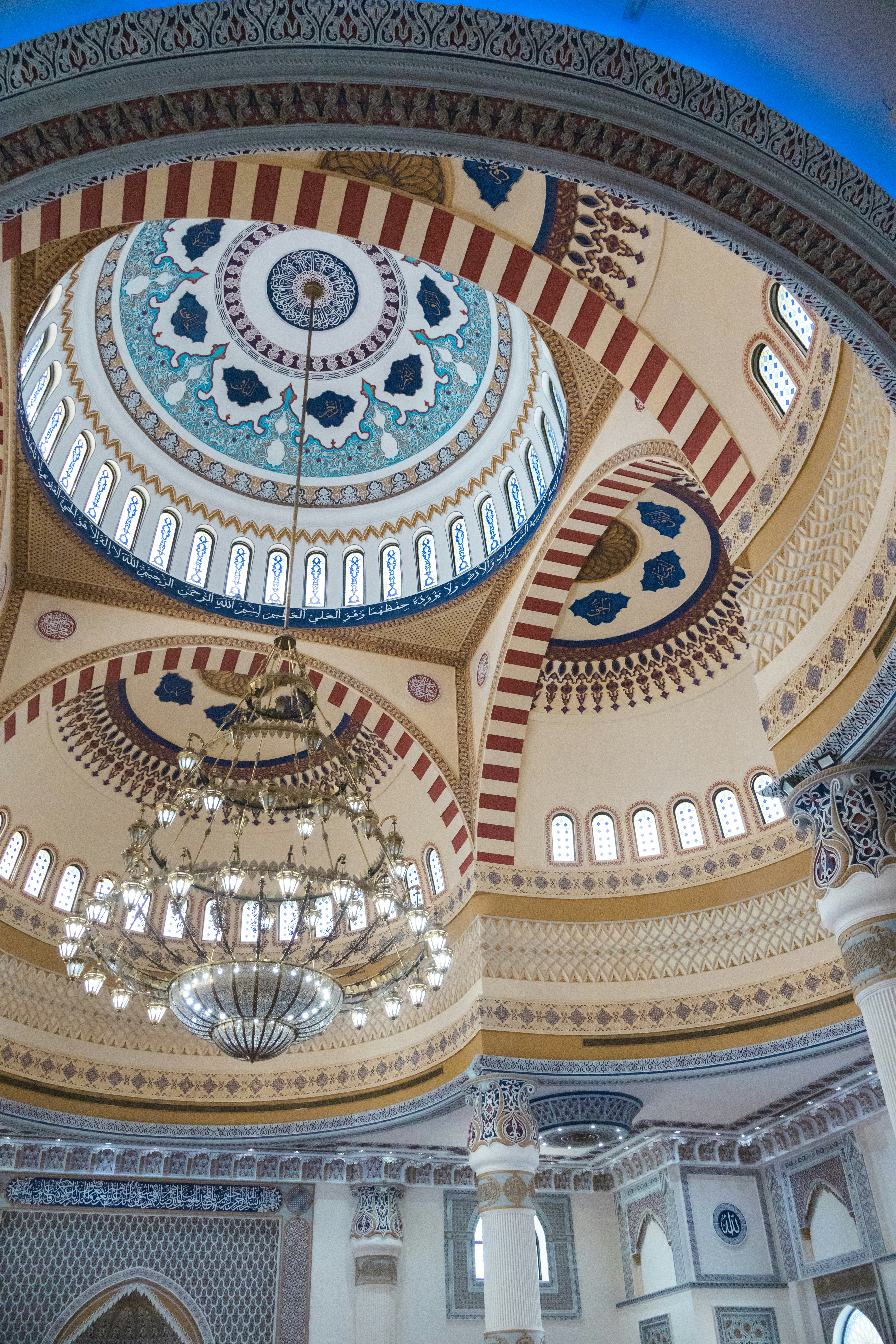 A domed ceiling with chandeliers and a chandelier hanging from the ...