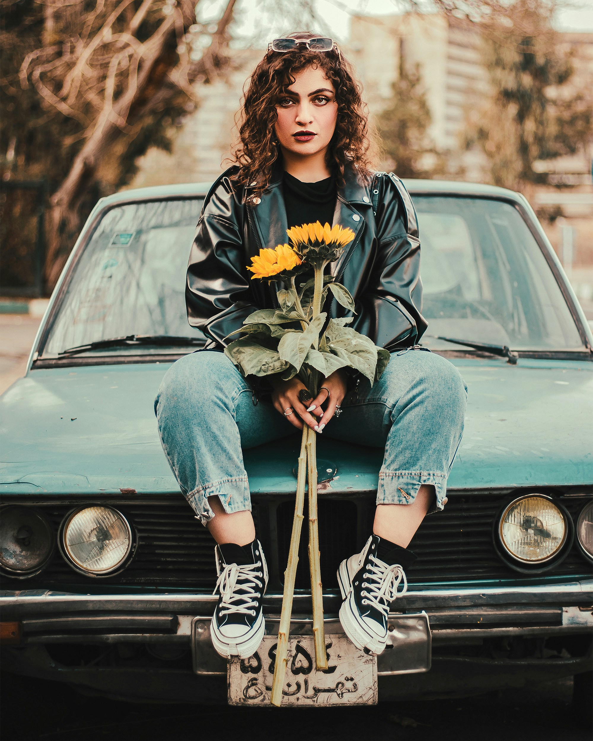Sunflowers on Chrome: A Quiet Portrait on a Vintage Green Car