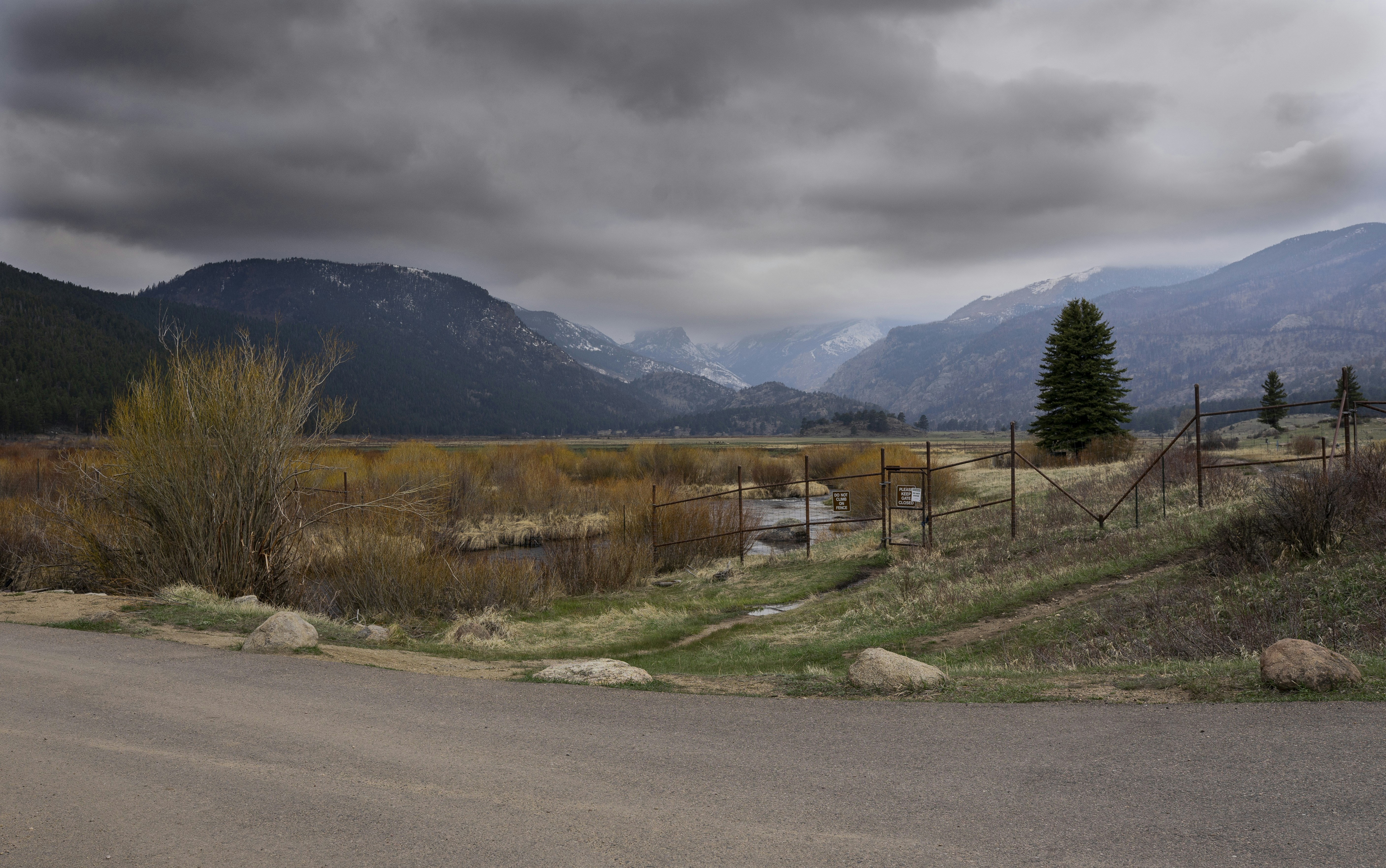 Fence-Line Toward a Cloud-Wrapped Mountain Range