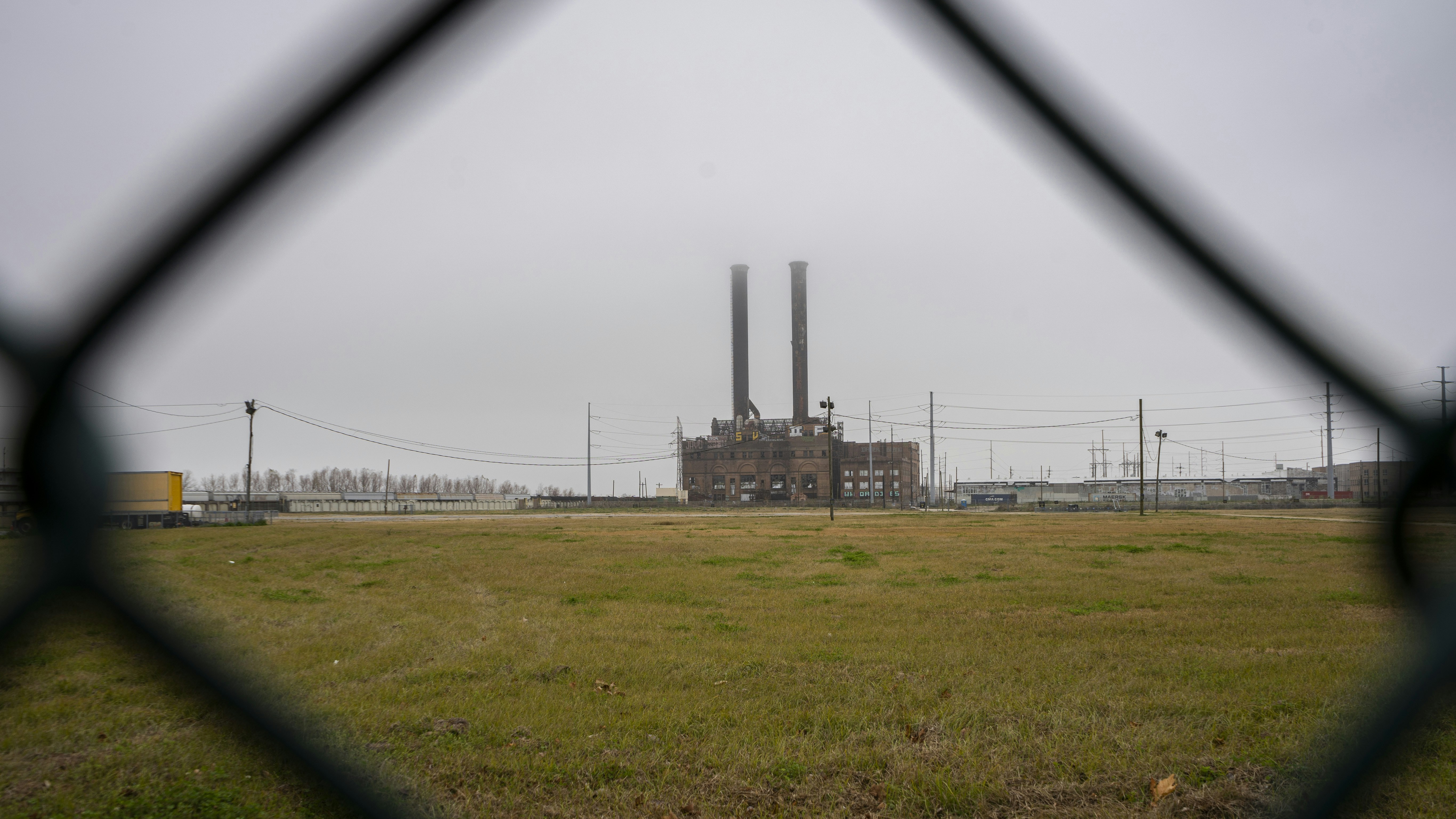 Fence-Frame Frontier: Twin Smokestacks on the Quiet Plain