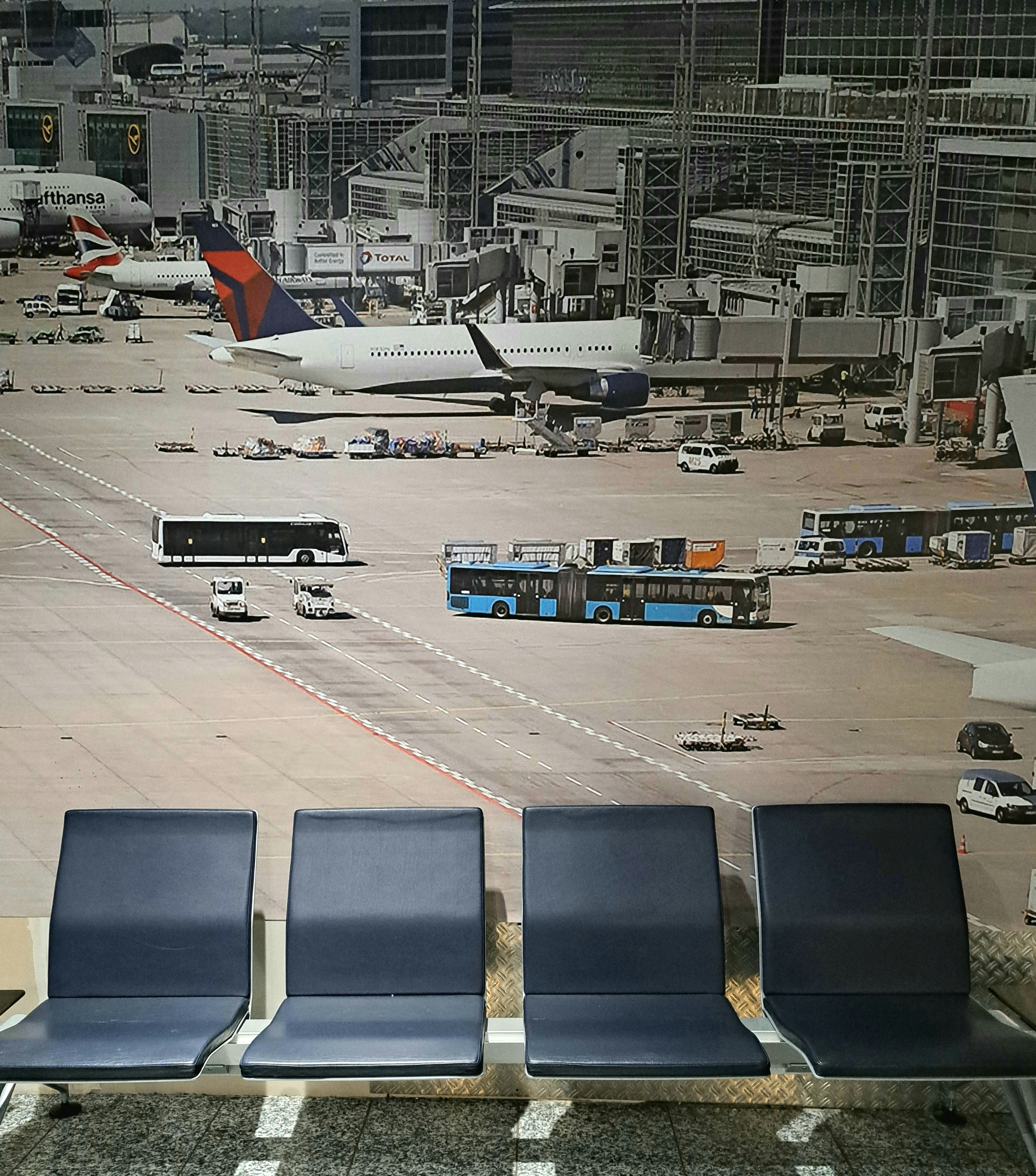 Blue Seats Overlooking the Runway: Quiet Tarmac Vantage