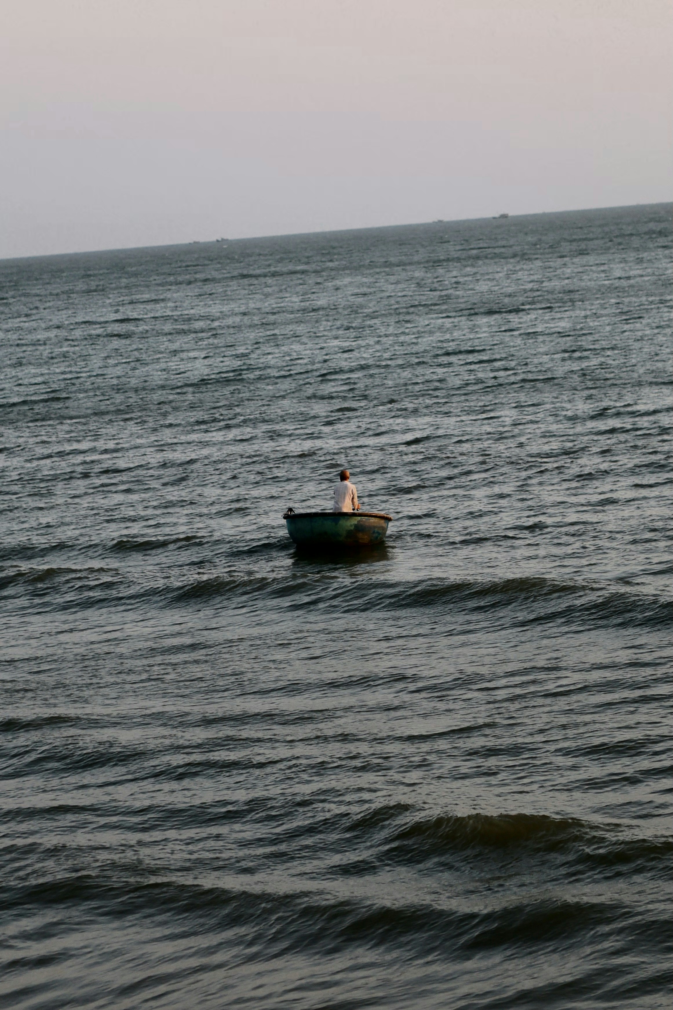 Evening Solitude: A Lone Boat Drifts on the Quiet Sea.