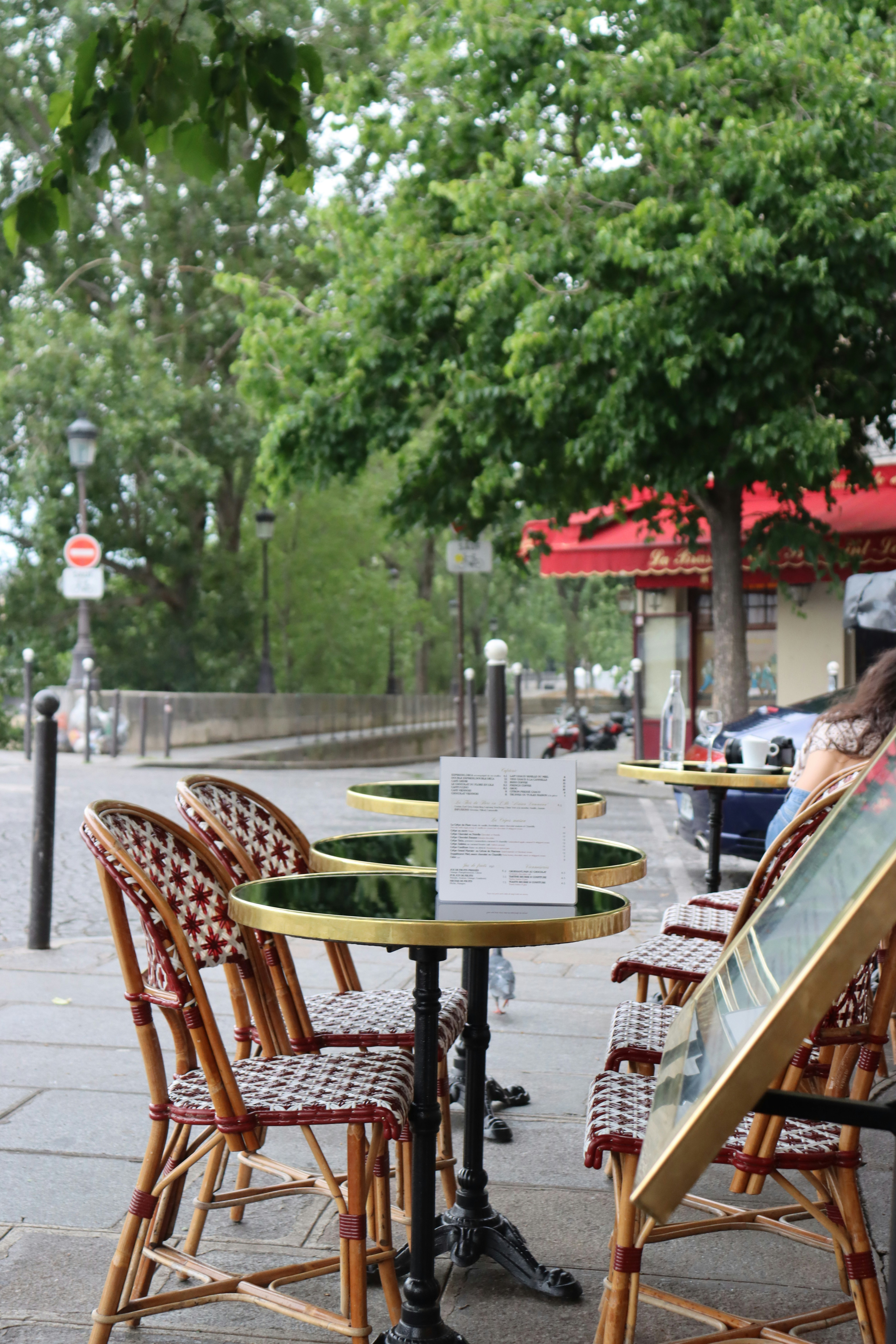 Round-Table Quiet: A Sunlit Café Terrace with a Menu Card as Focal Point