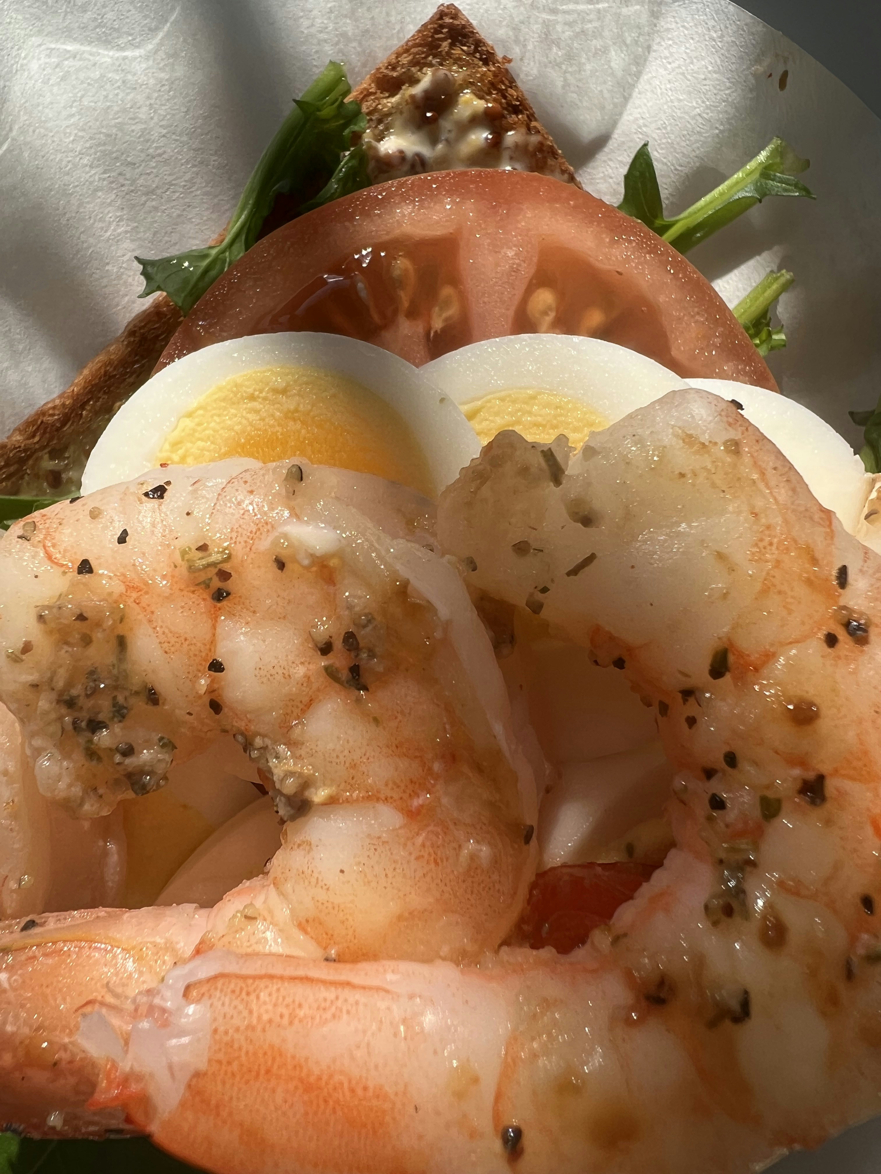 Coastal Bite: Shrimp on Toast with Tomato and Egg Slices in Warm Light