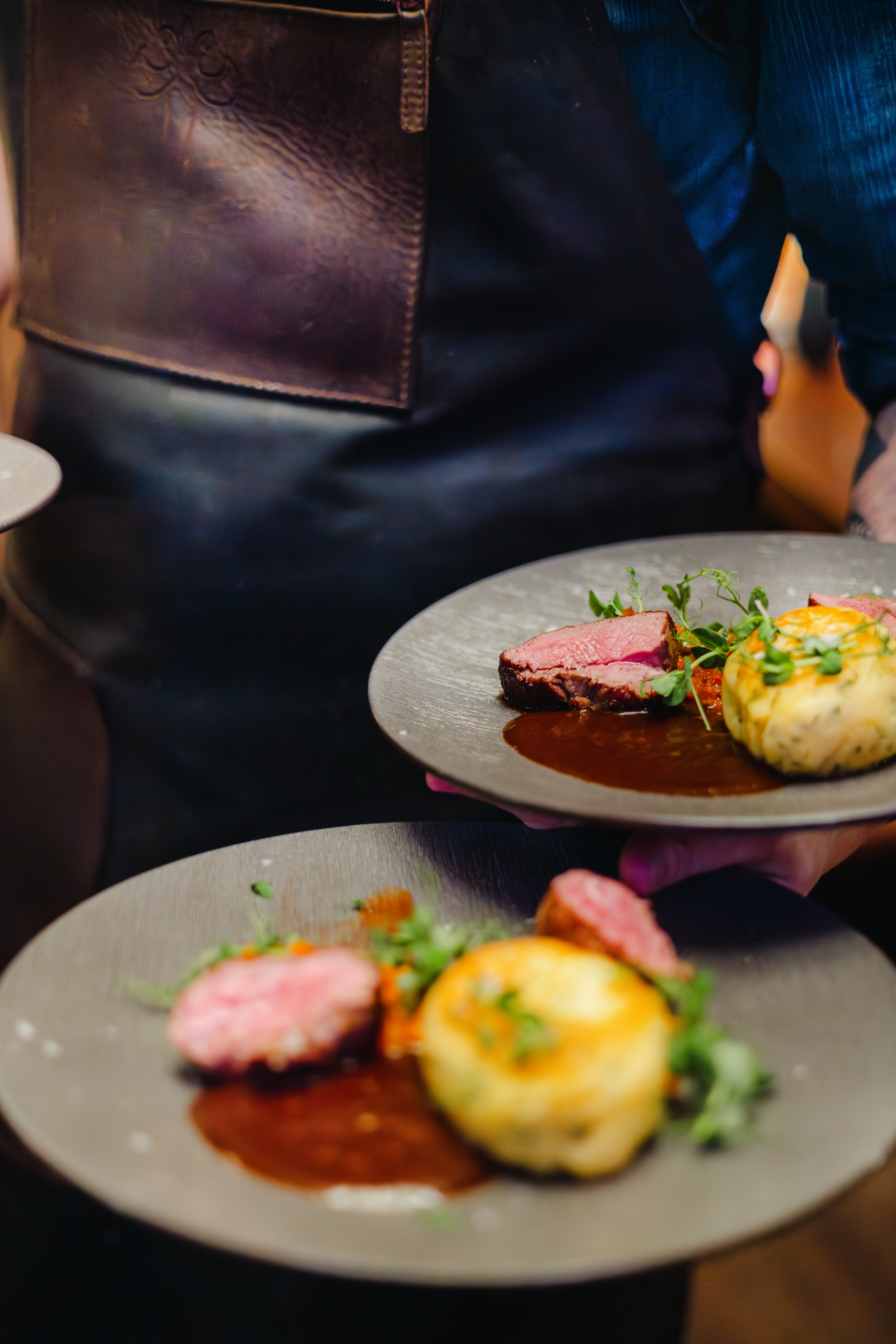 Leather Apron, Twin Plates: A Quiet Kitchen Moment