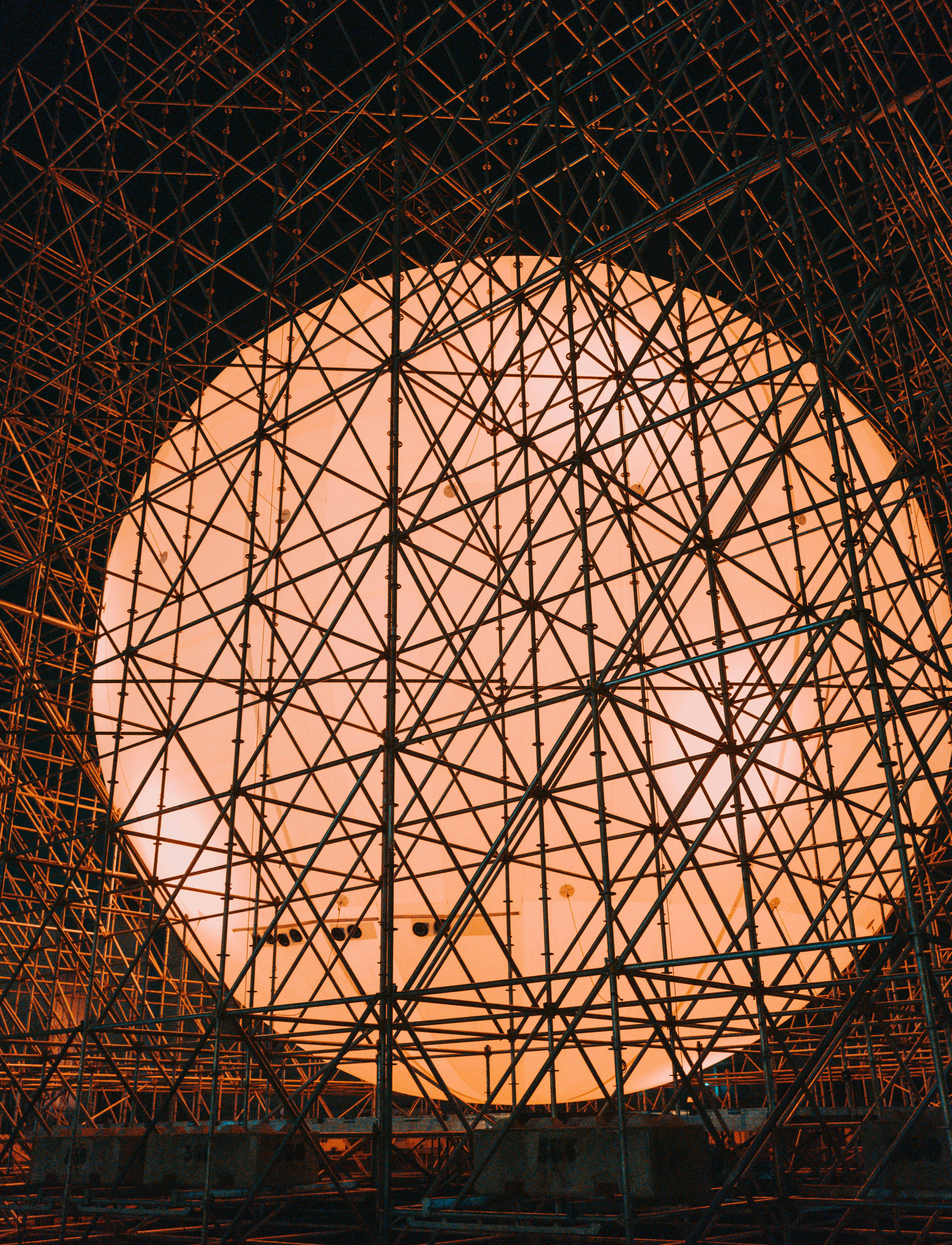 A large circular structure with many scaffolding around it photo – Free ...