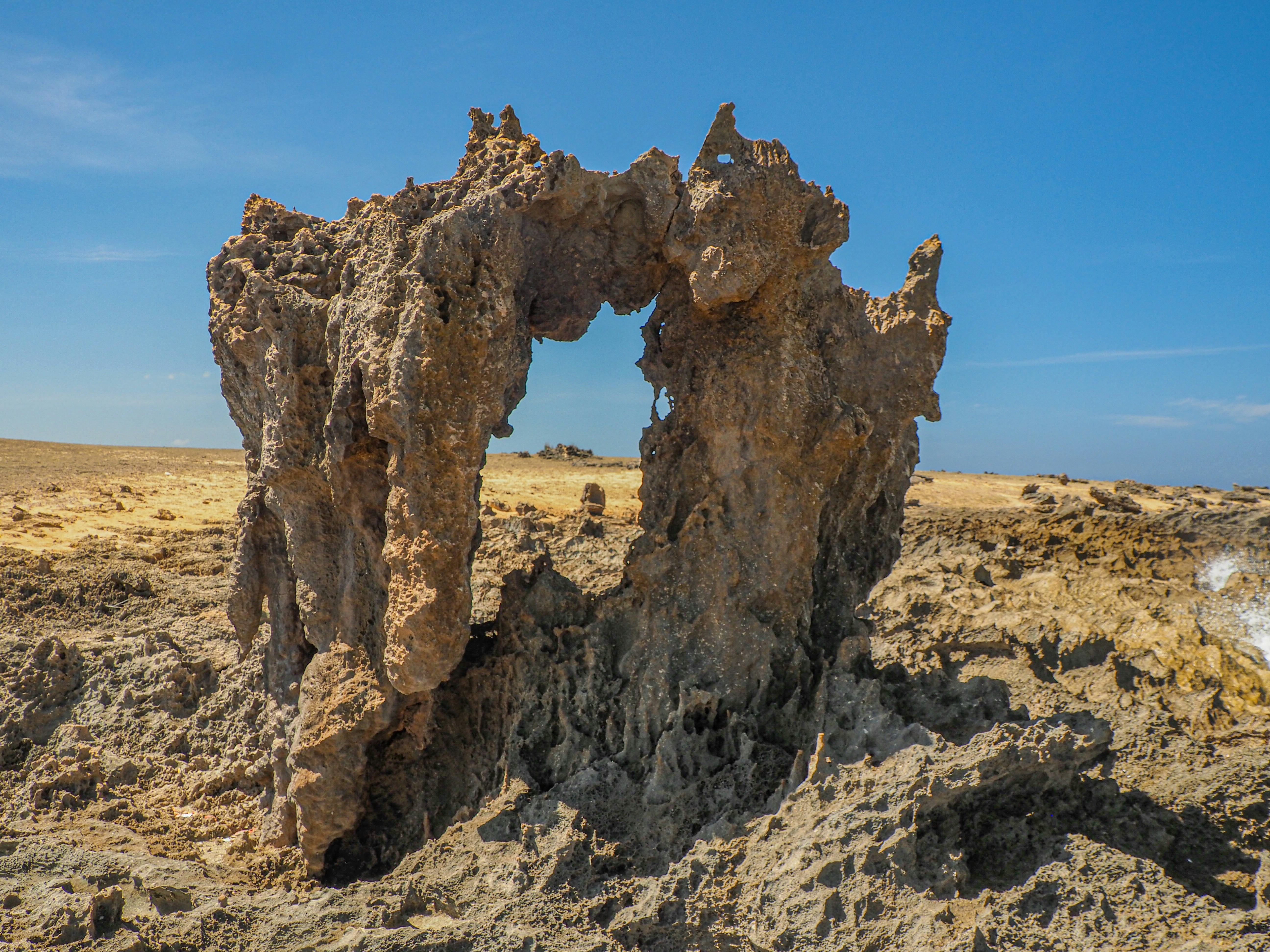 A rock formation in the middle of a desert photo – Free Sea Image on ...