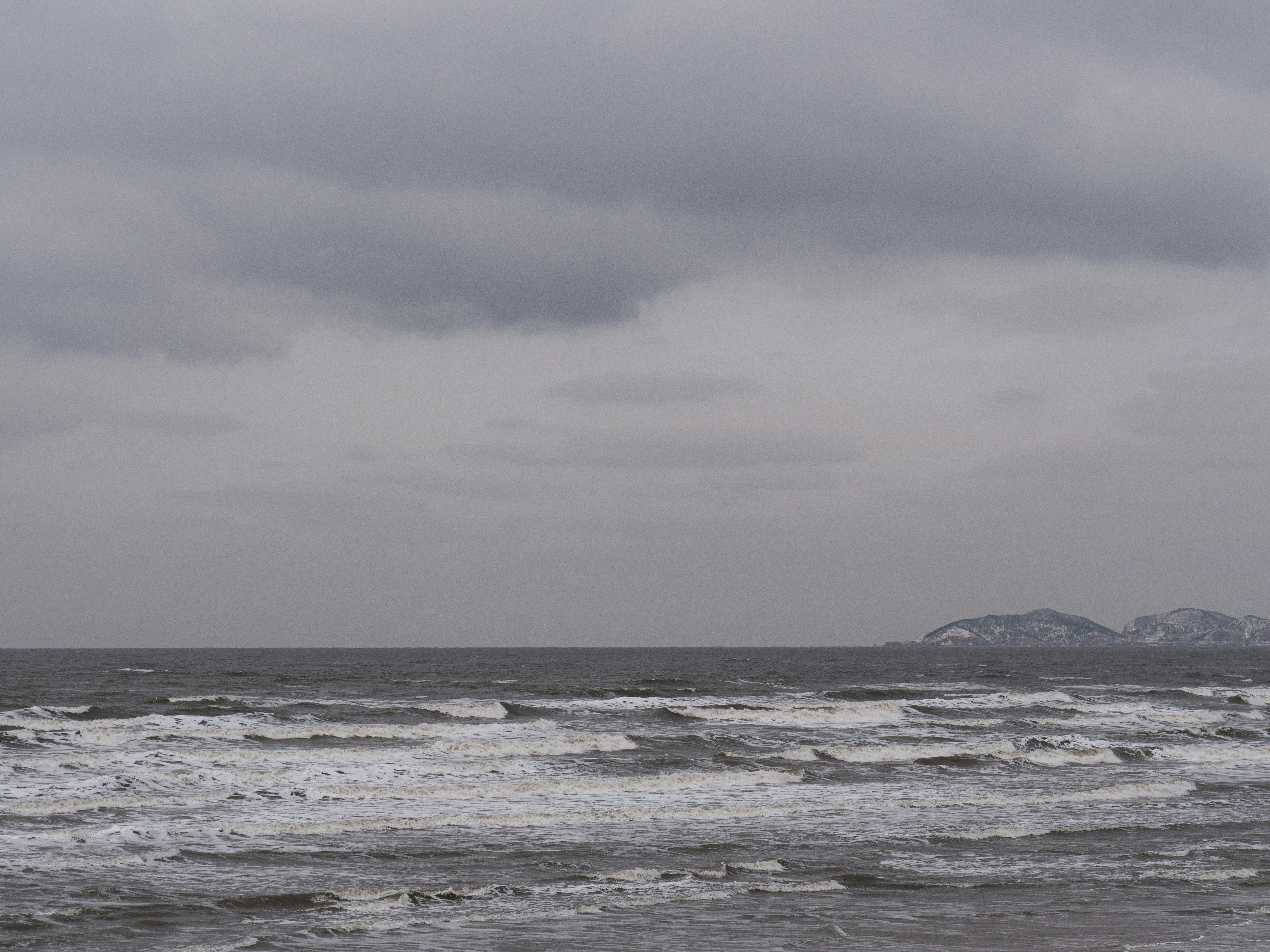 Distant Isles at the Edge of a Leaden Sea