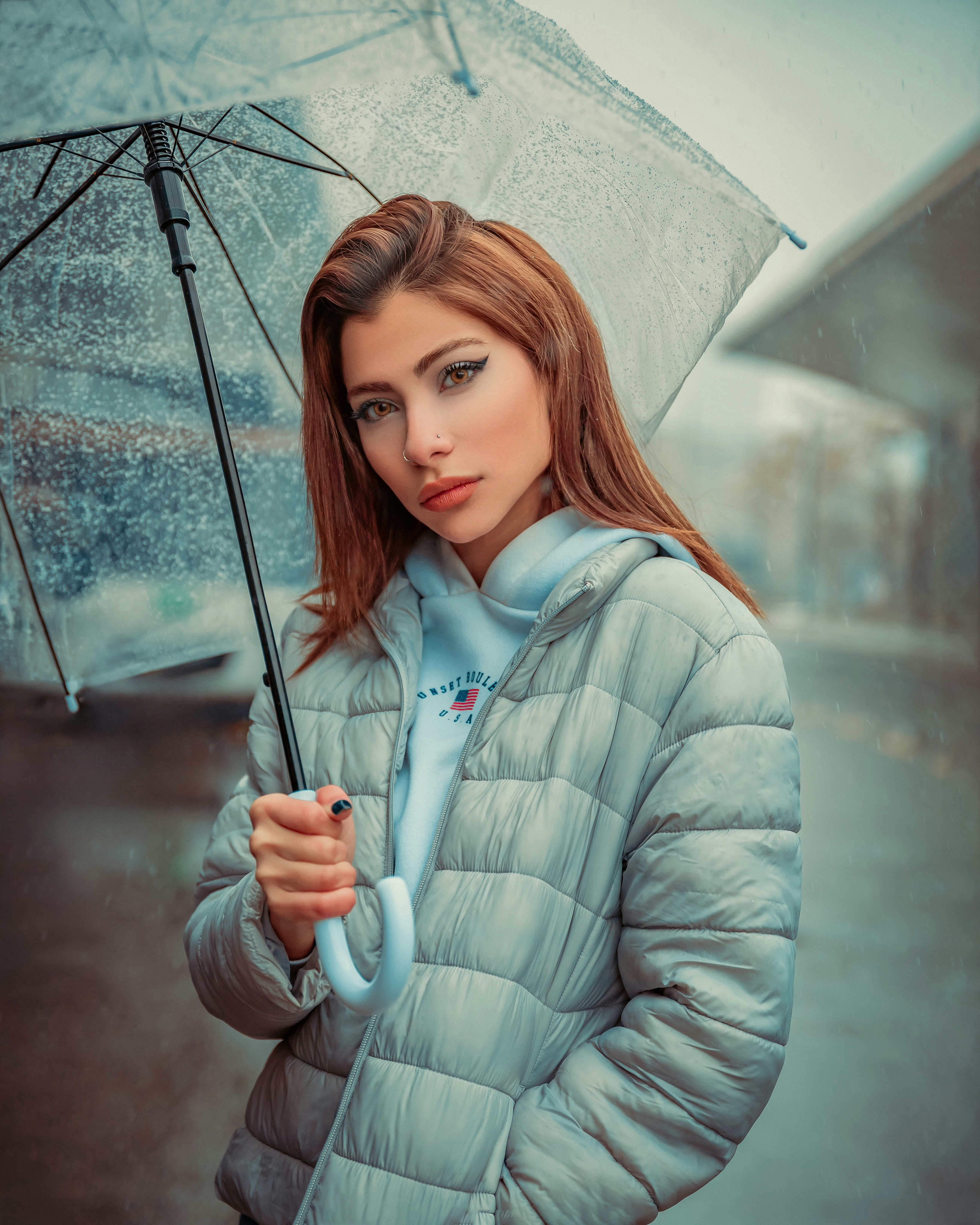 Rain-Soaked Quiet: Portrait under a Transparent Umbrella