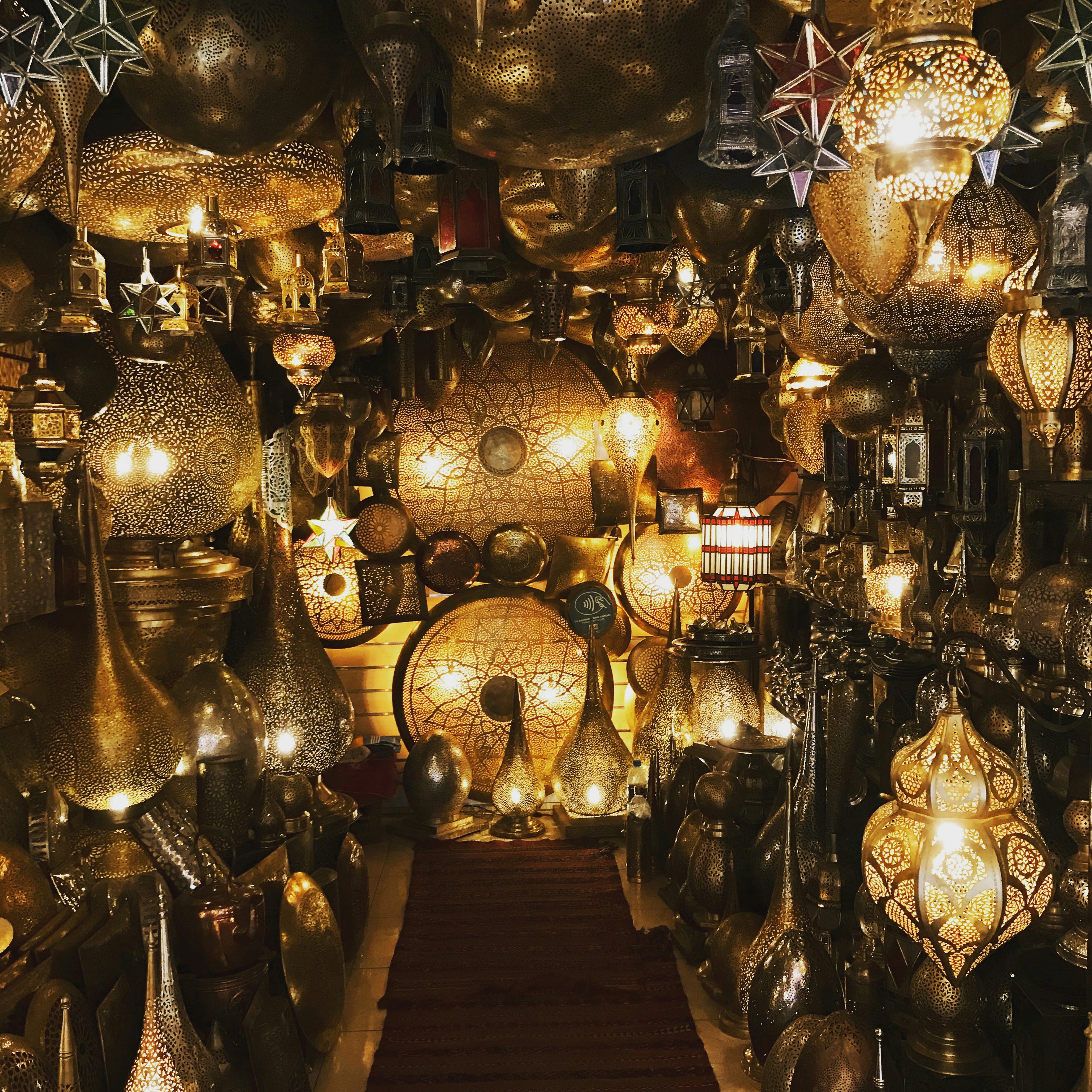 A room filled with lots of lamps and lights photo – Free Brown Image on ...