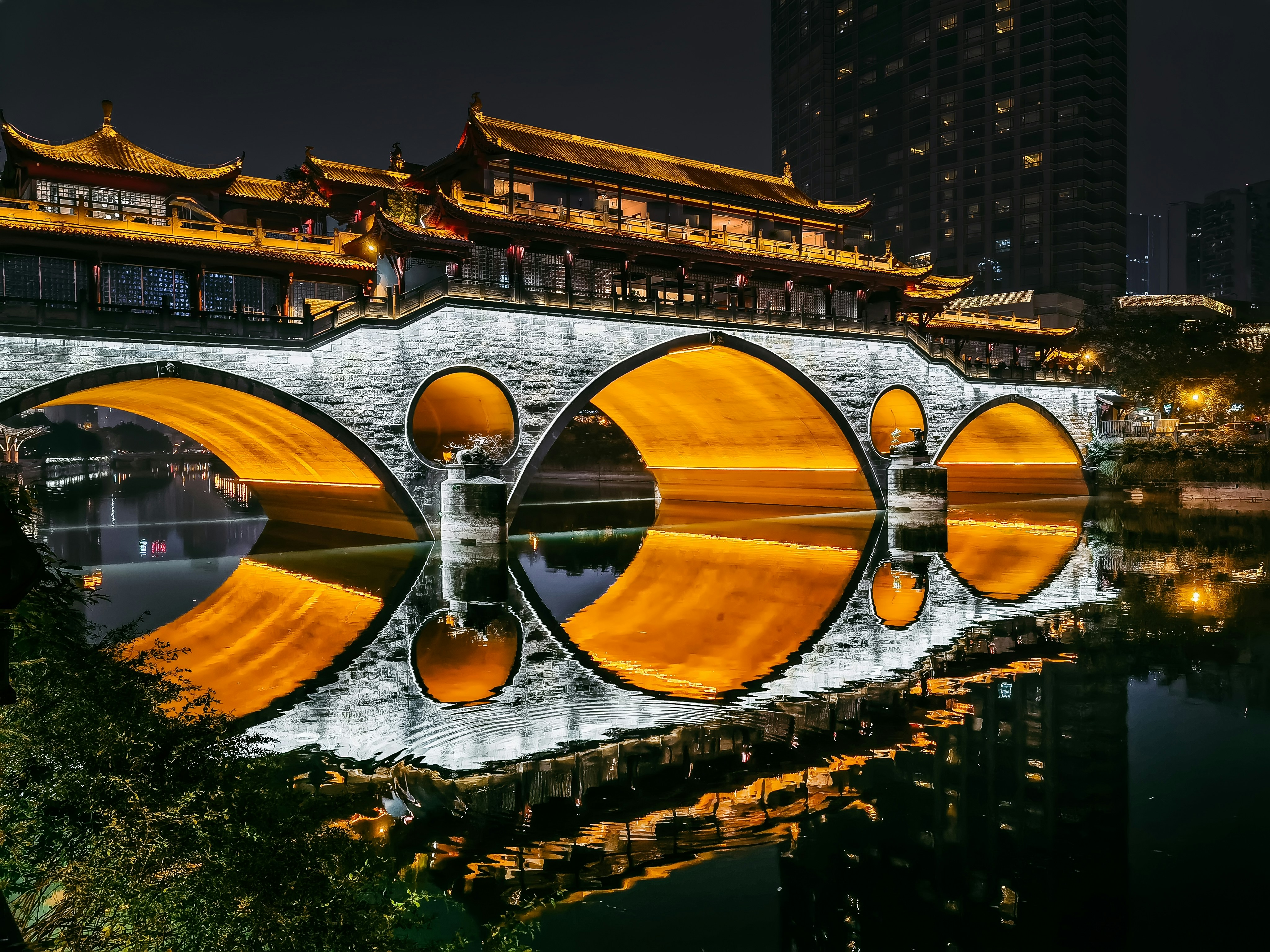 Midnight Golden Arches: Reflections on a Lantern Bridge