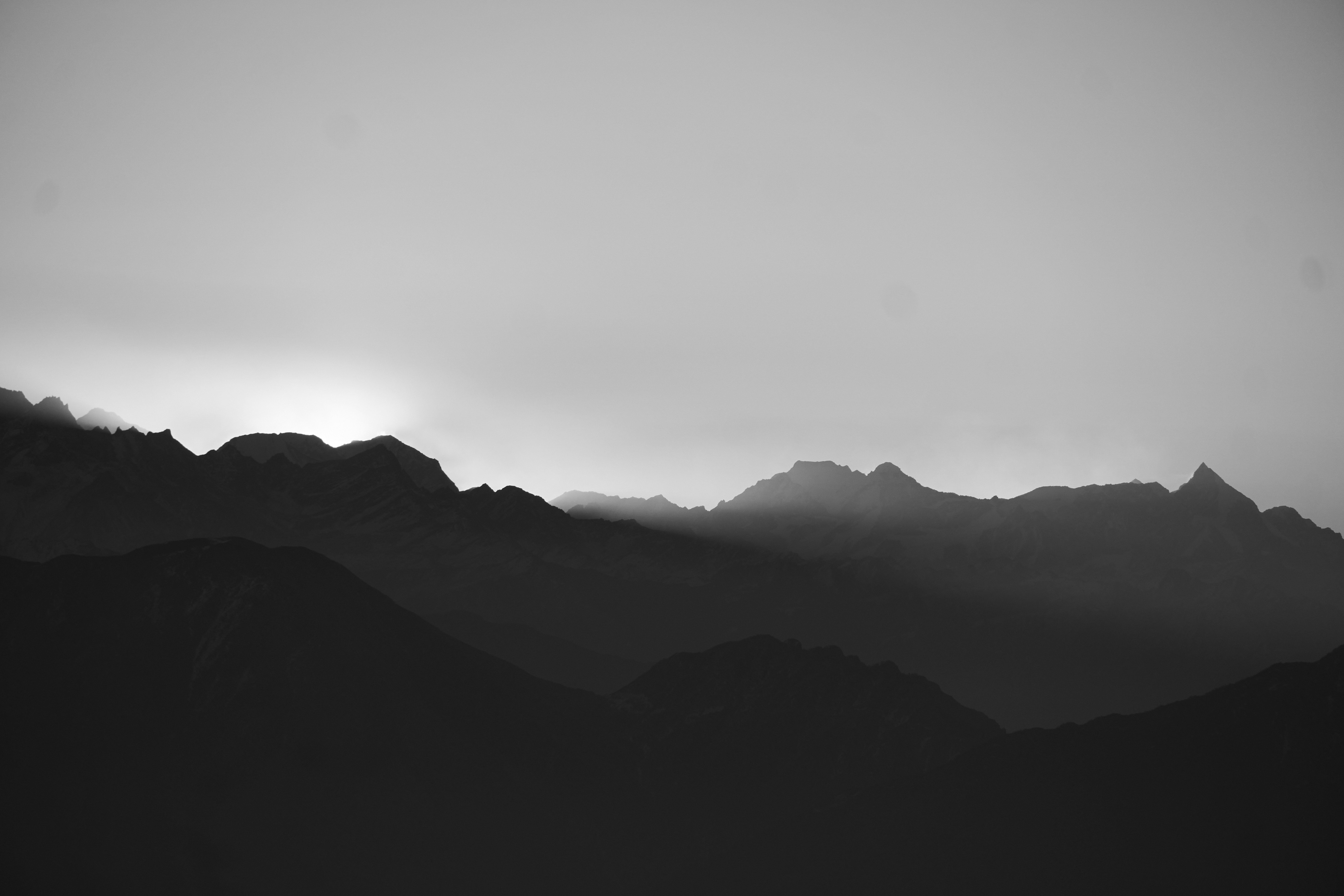 a black and white photo of a mountain range