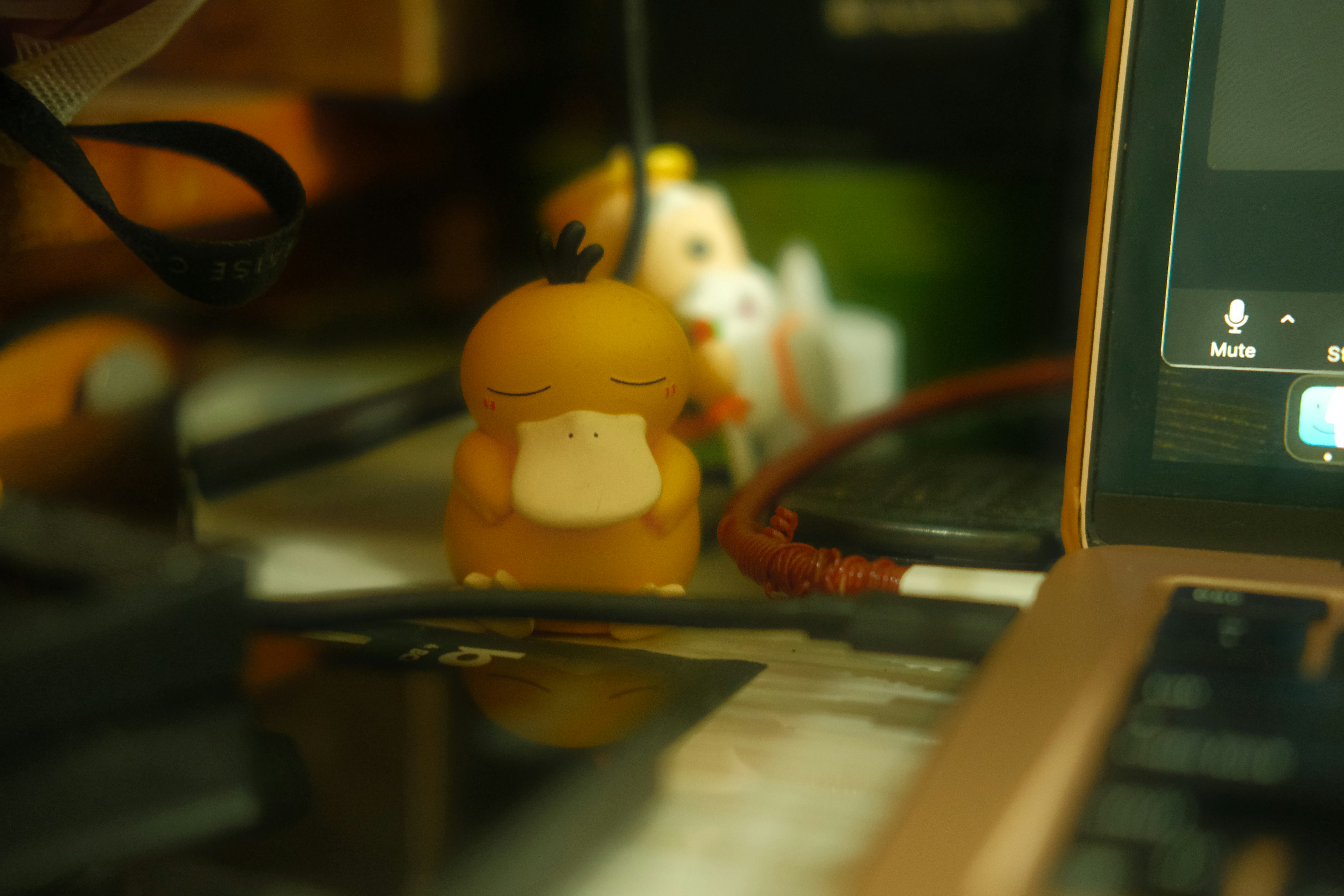 A small toy sitting next to a laptop computer photo – Free Psyduck ...