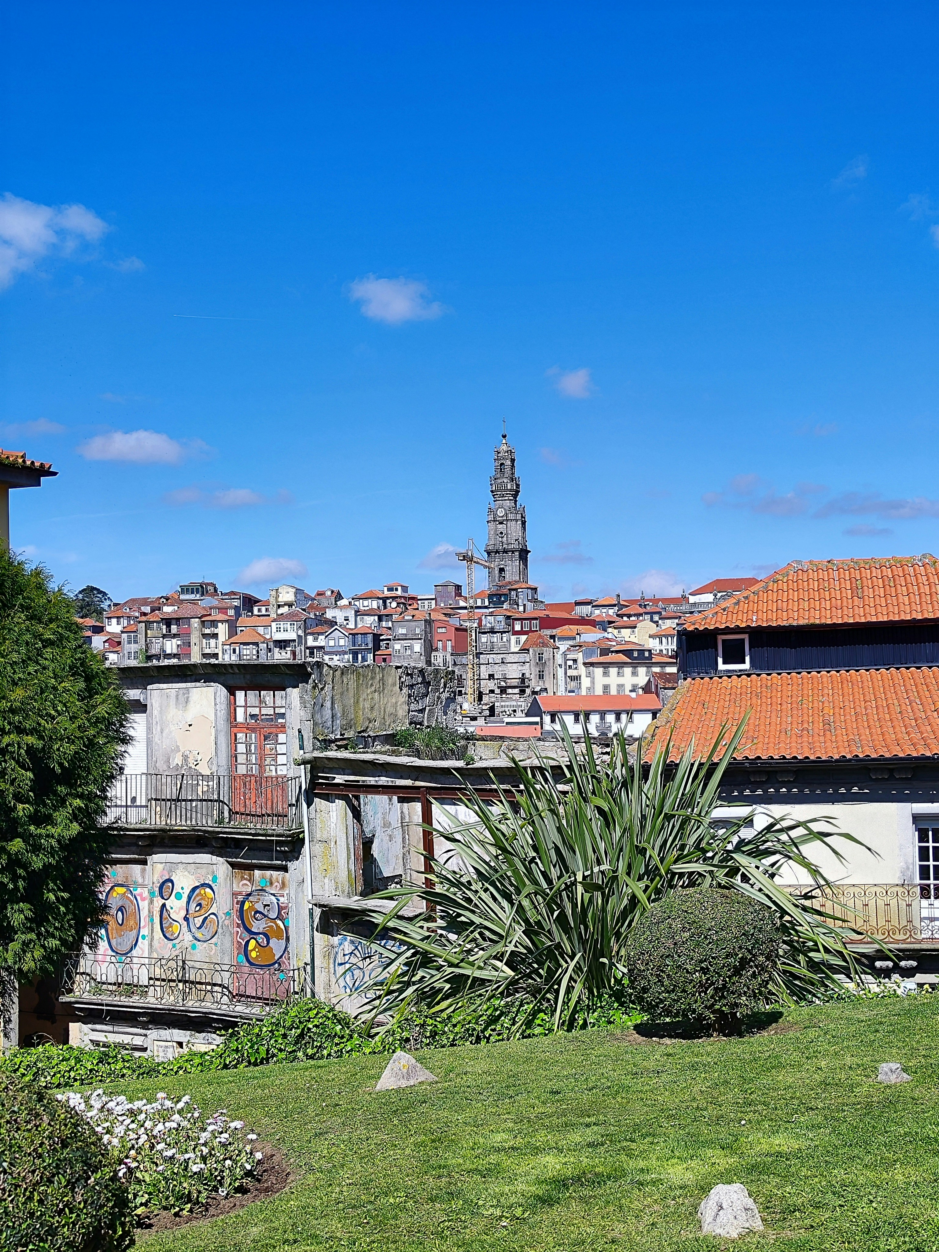 Bell Tower Against a Sea of Red Rooftops Under a Pristine Blue Sky