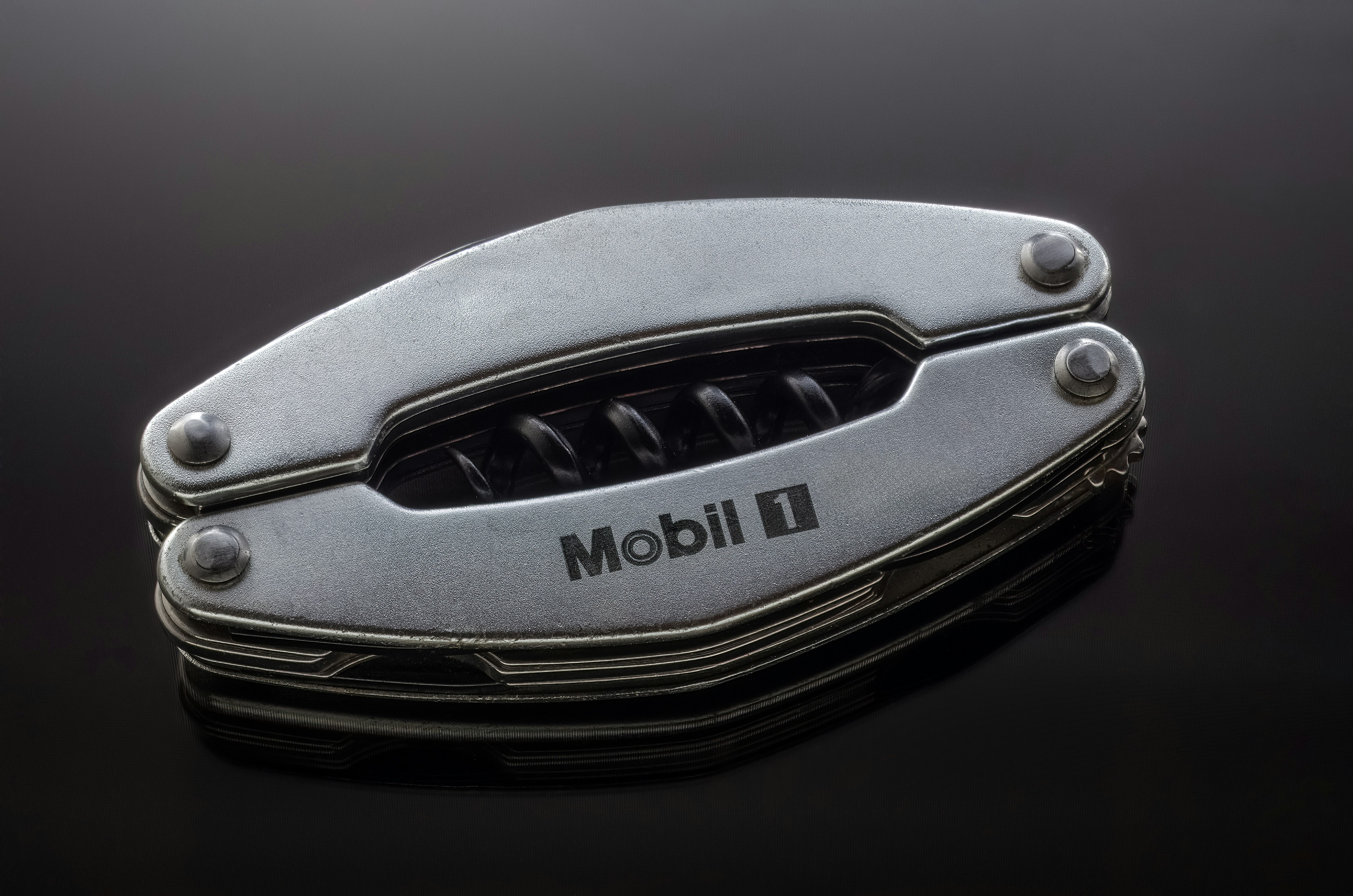 Emblem in Metal: Macro Portrait of a Mobil 1 Pocket Multitool