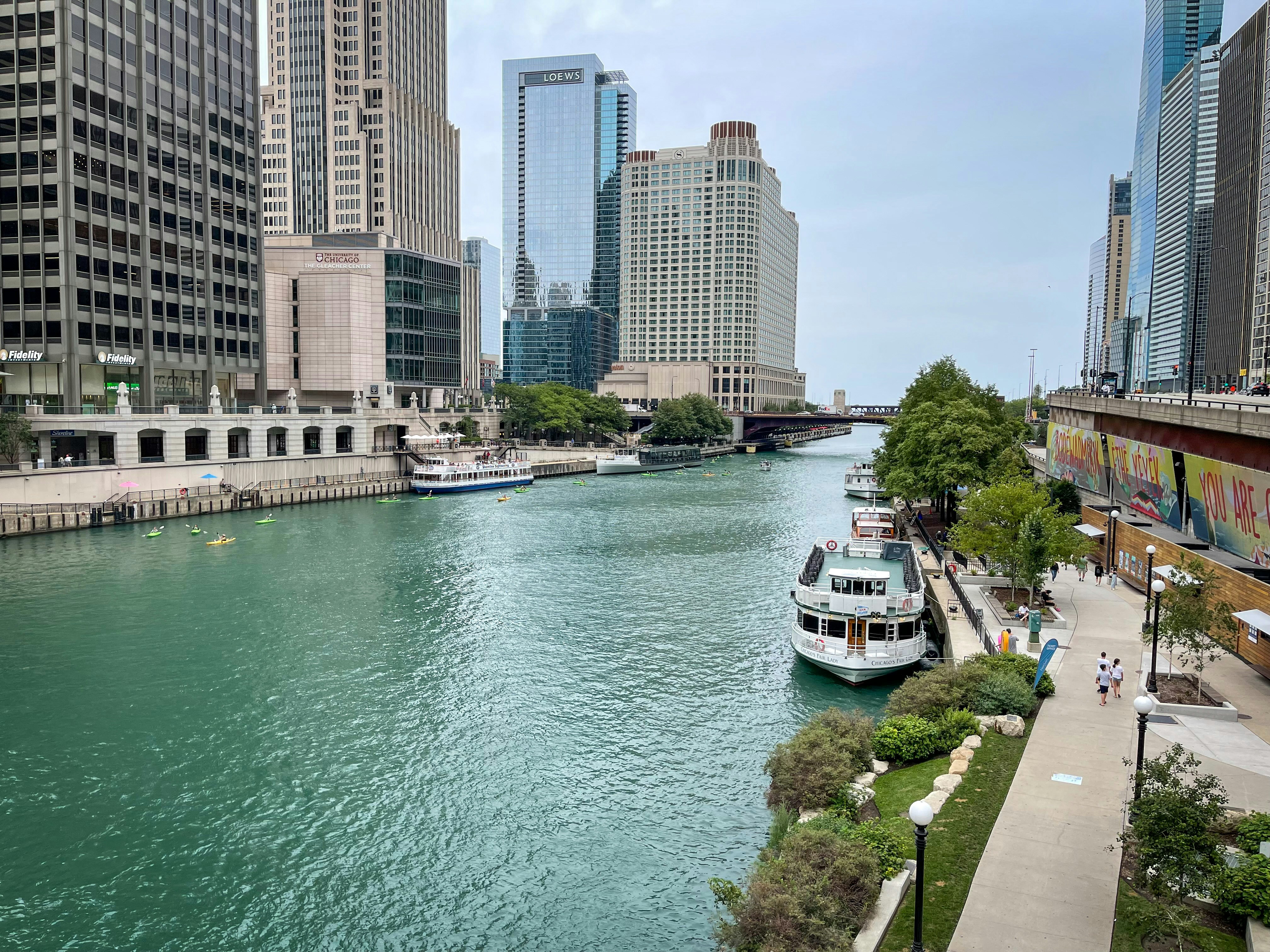Canal Echo: A Riverwalk Framed by Glass Giants