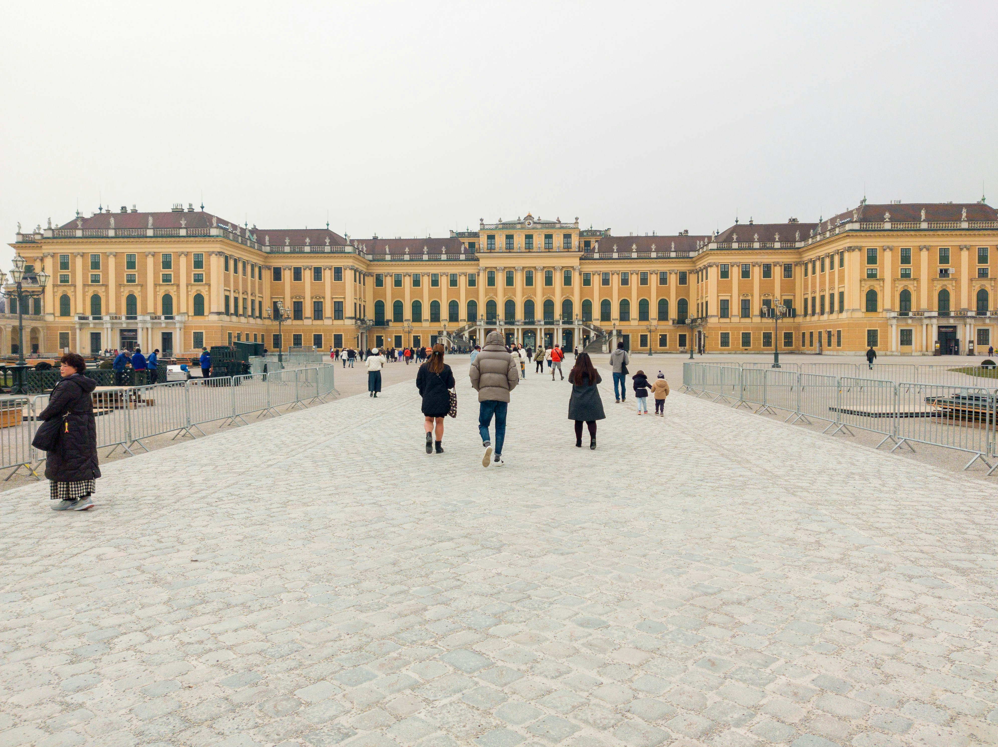Gilded Approach: Pedestrians Converge on a Yellow Palace