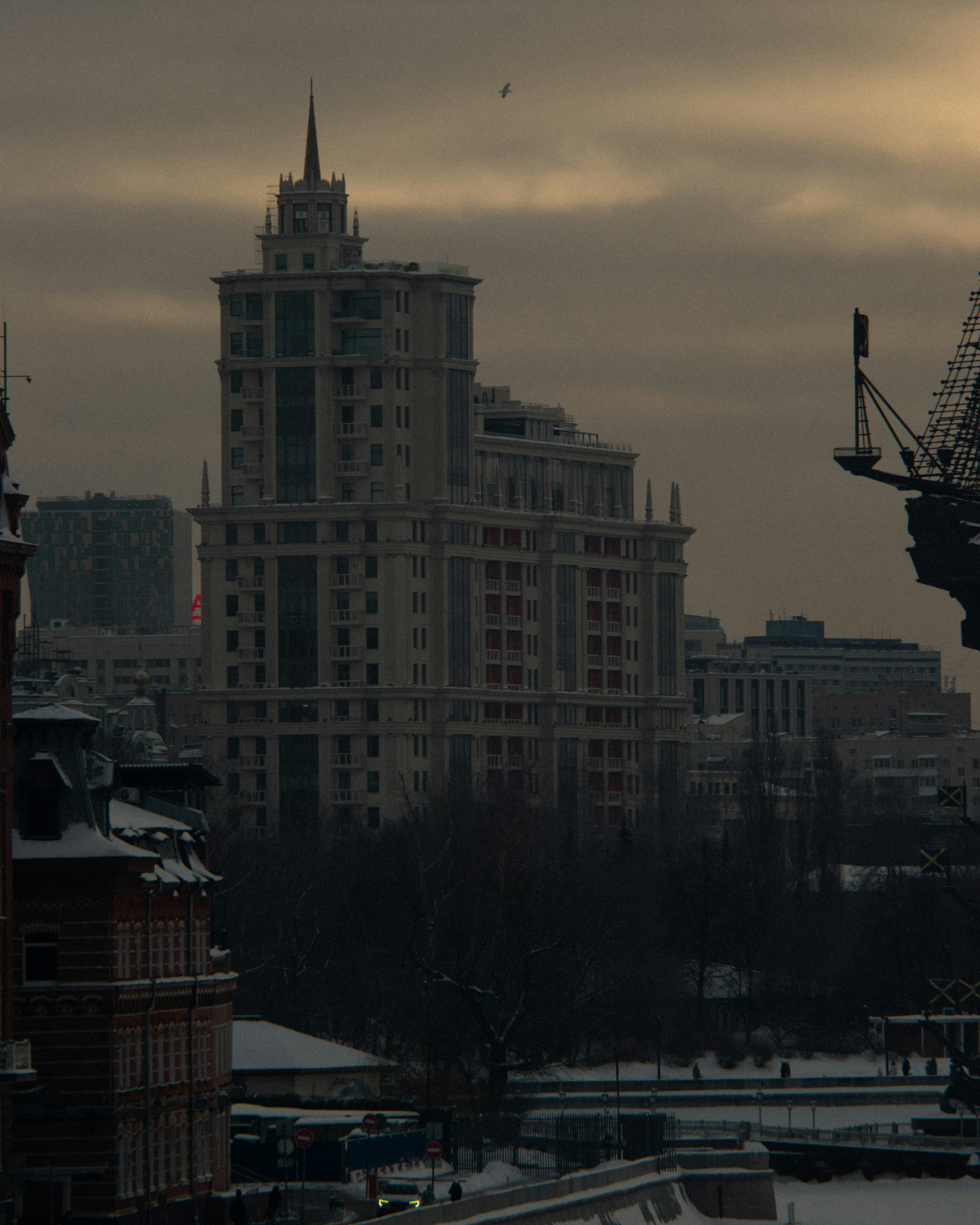 Dusk Over a Snowbound Skyline: A Tower Takes Shape Amid Cranes