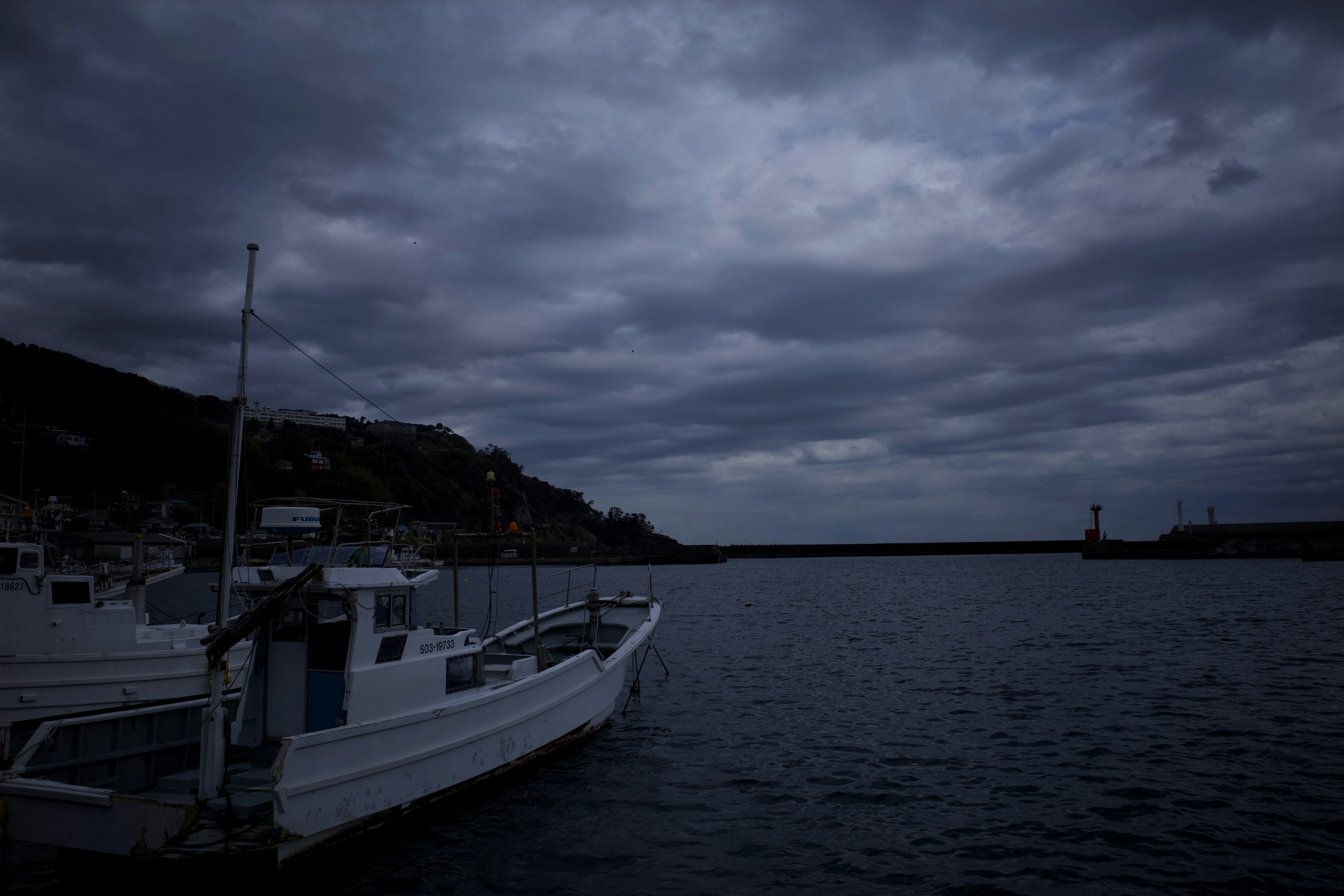 Dusk Harbor: Boats Beneath a Brooding Sky