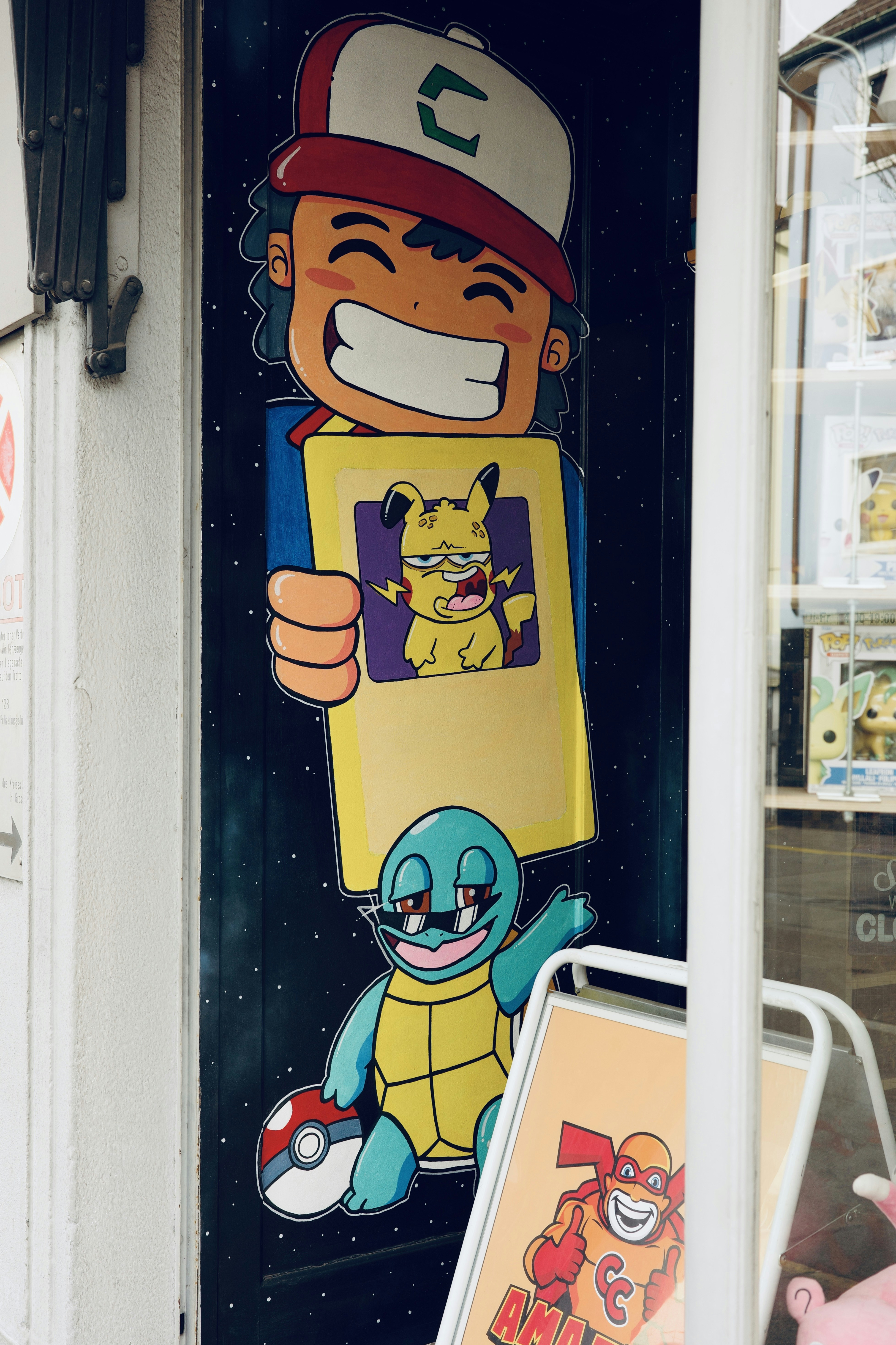 Smiling Street Mascot Holds Pikachu Portrait in a Pokémon storefront mural