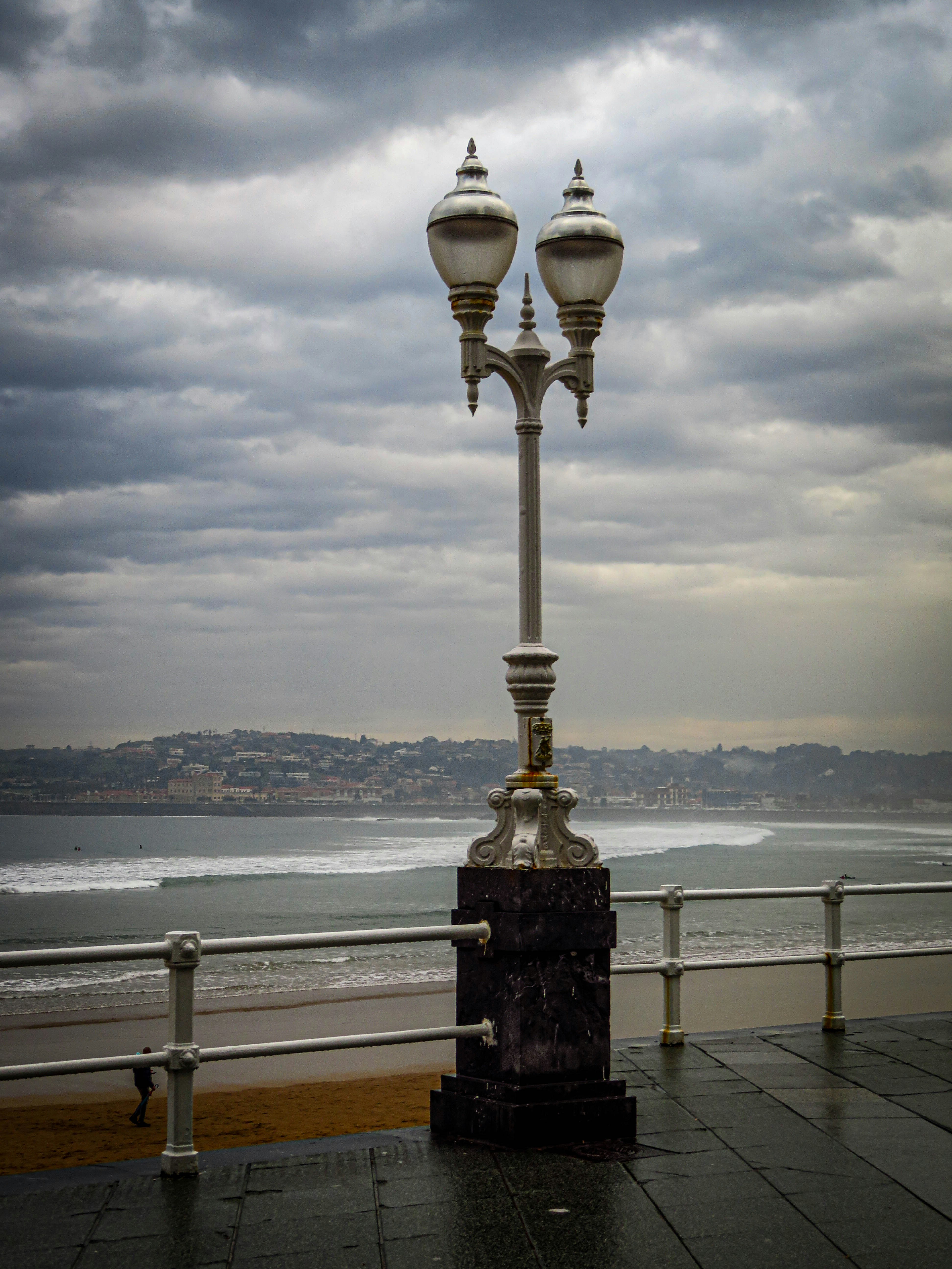 a street light sitting on the side of a road