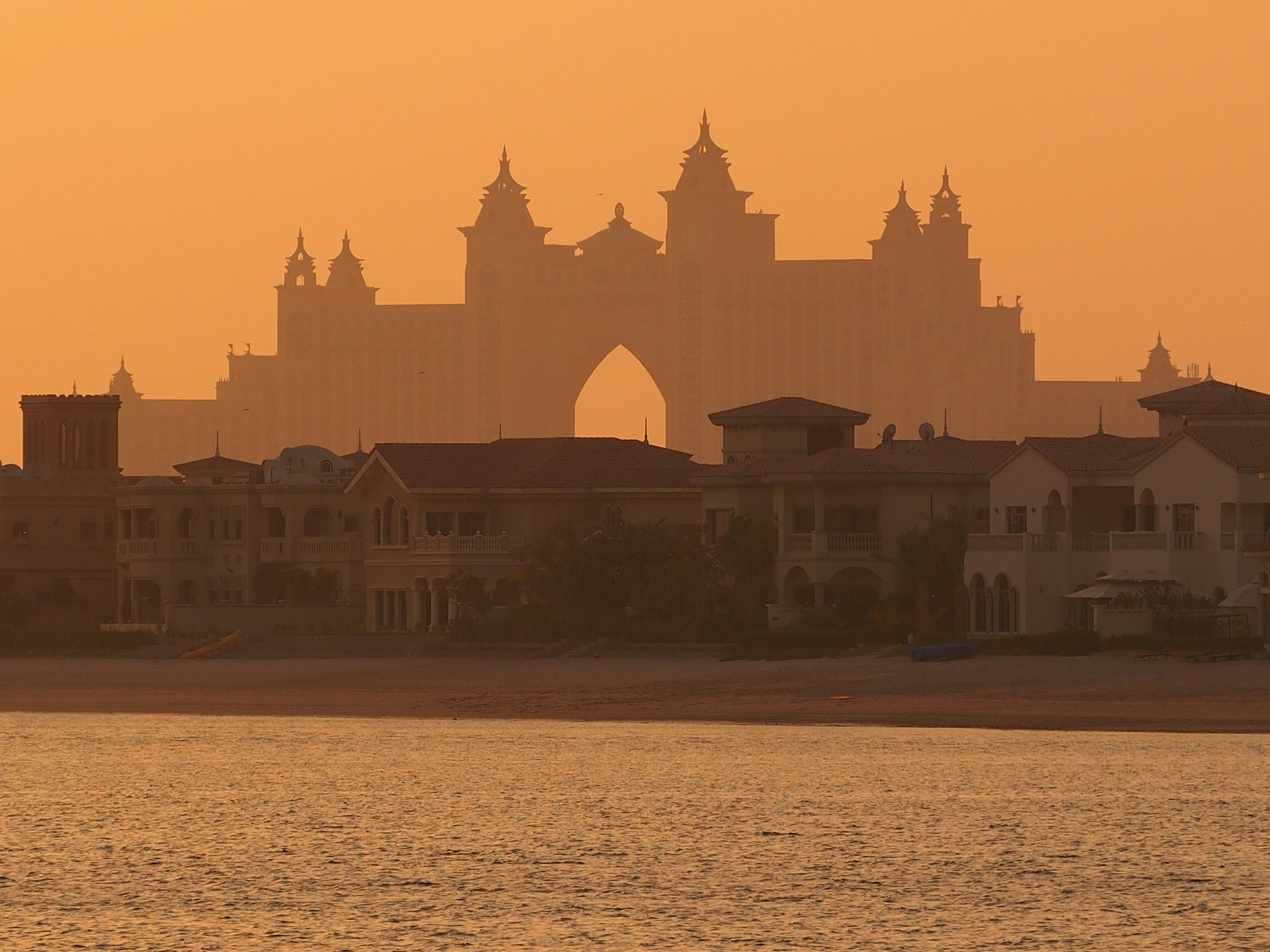Amber Gate at Dusk: Central Arch Rising Above a Quiet Shoreline
