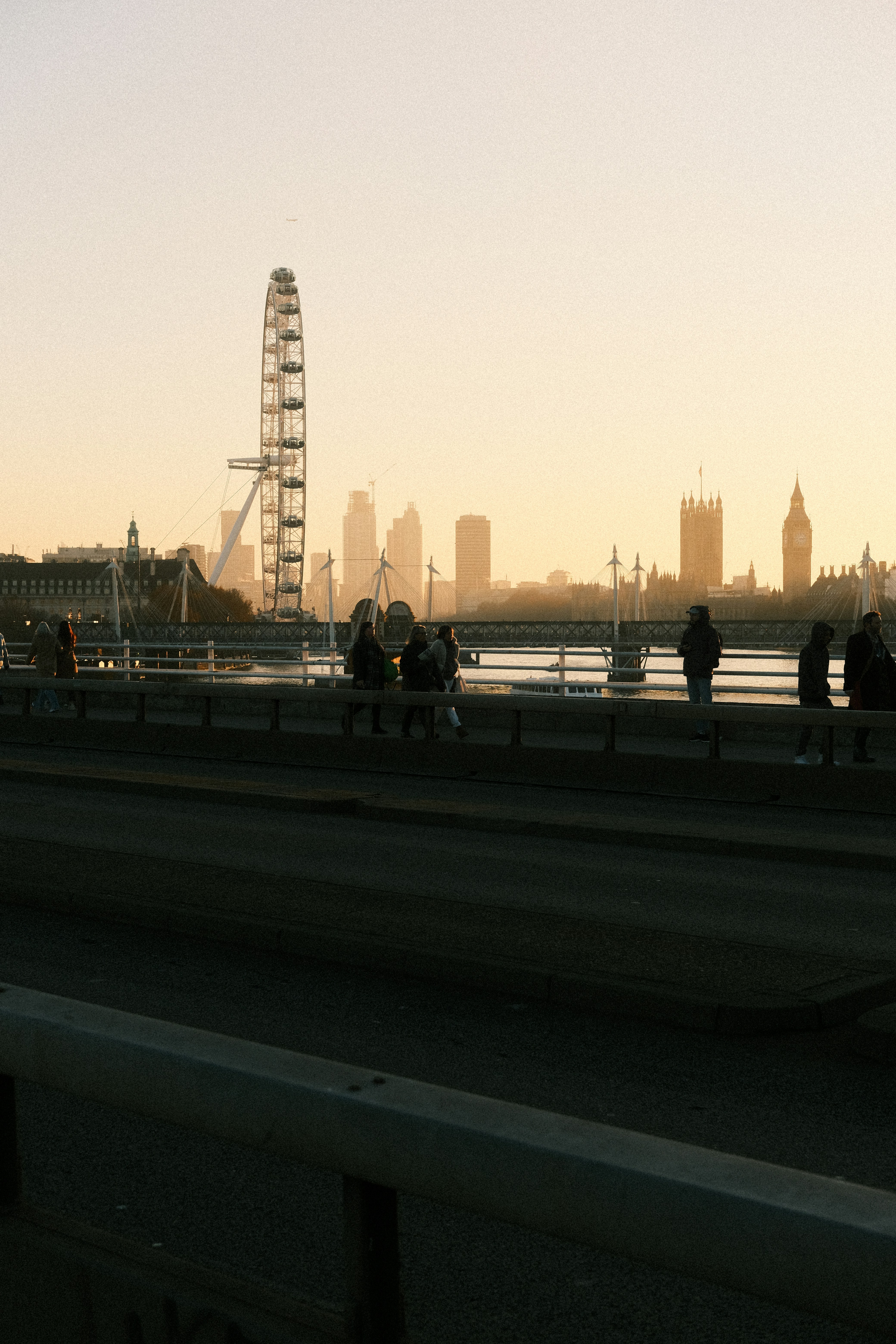 A group of people walking across a bridge photo – Free Uk Image on Unsplash