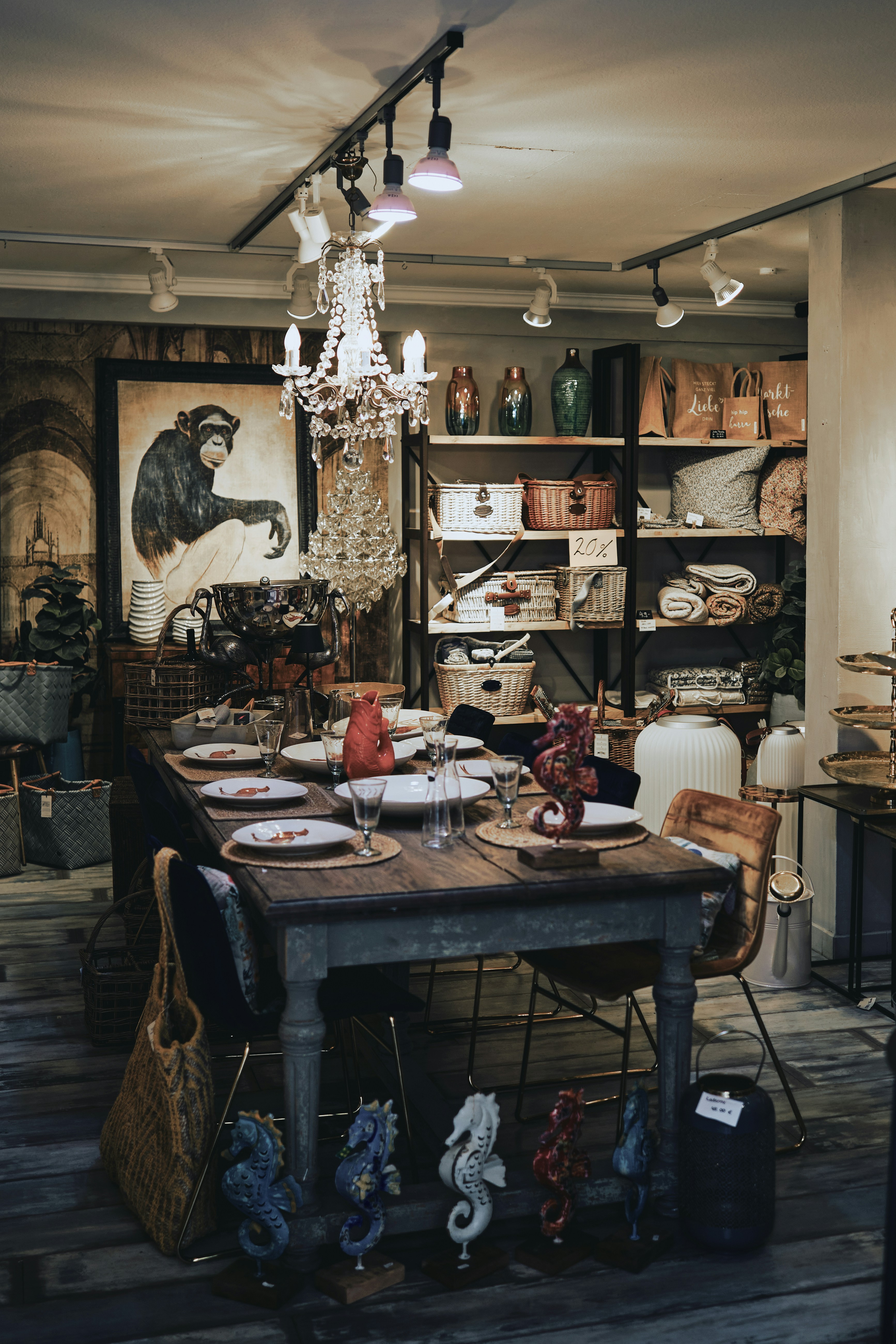 a dining room table with a chandelier hanging from the ceiling