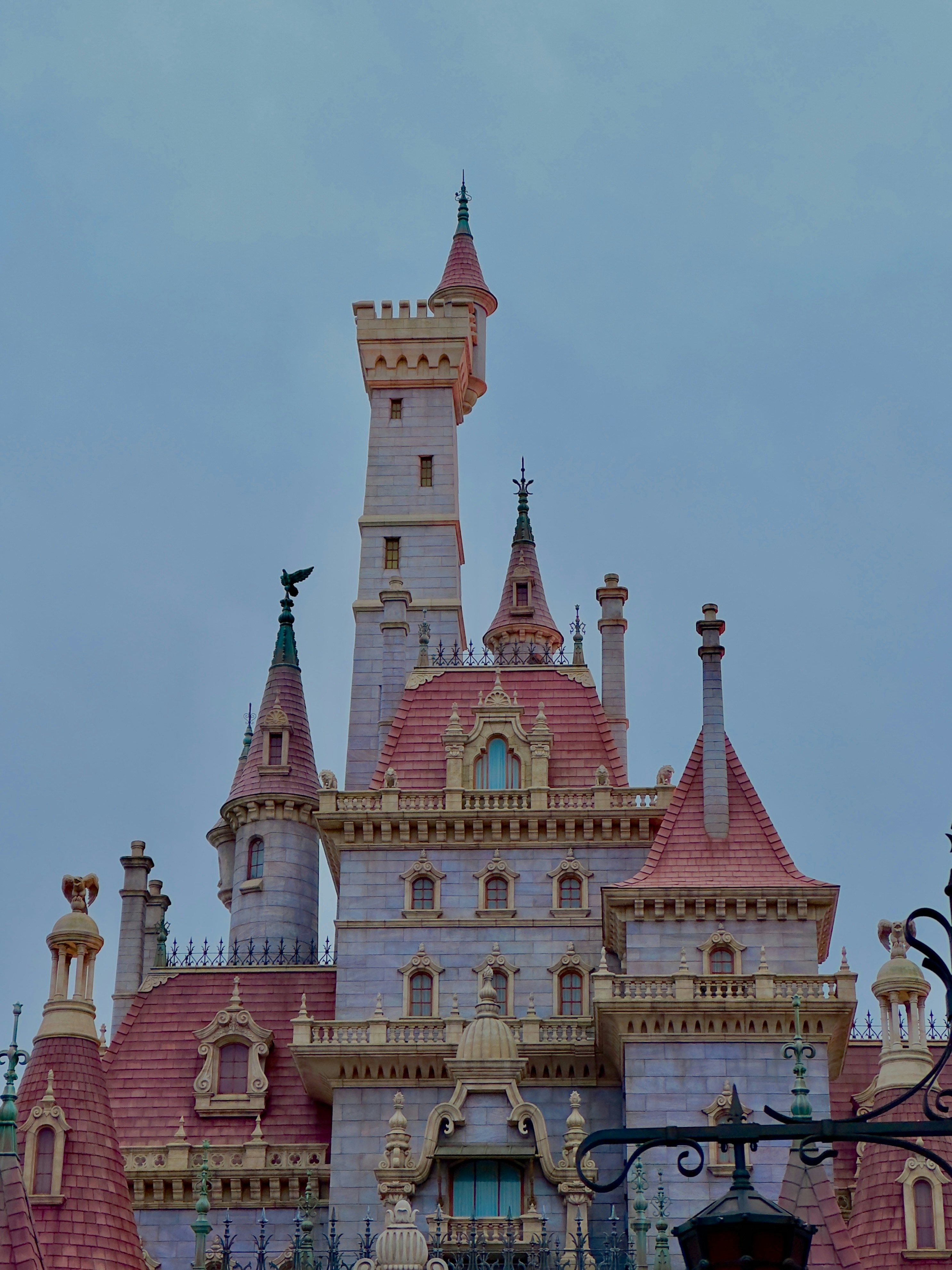 Pastel Citadel: Crowned Turrets Rising Against a Pale Sky