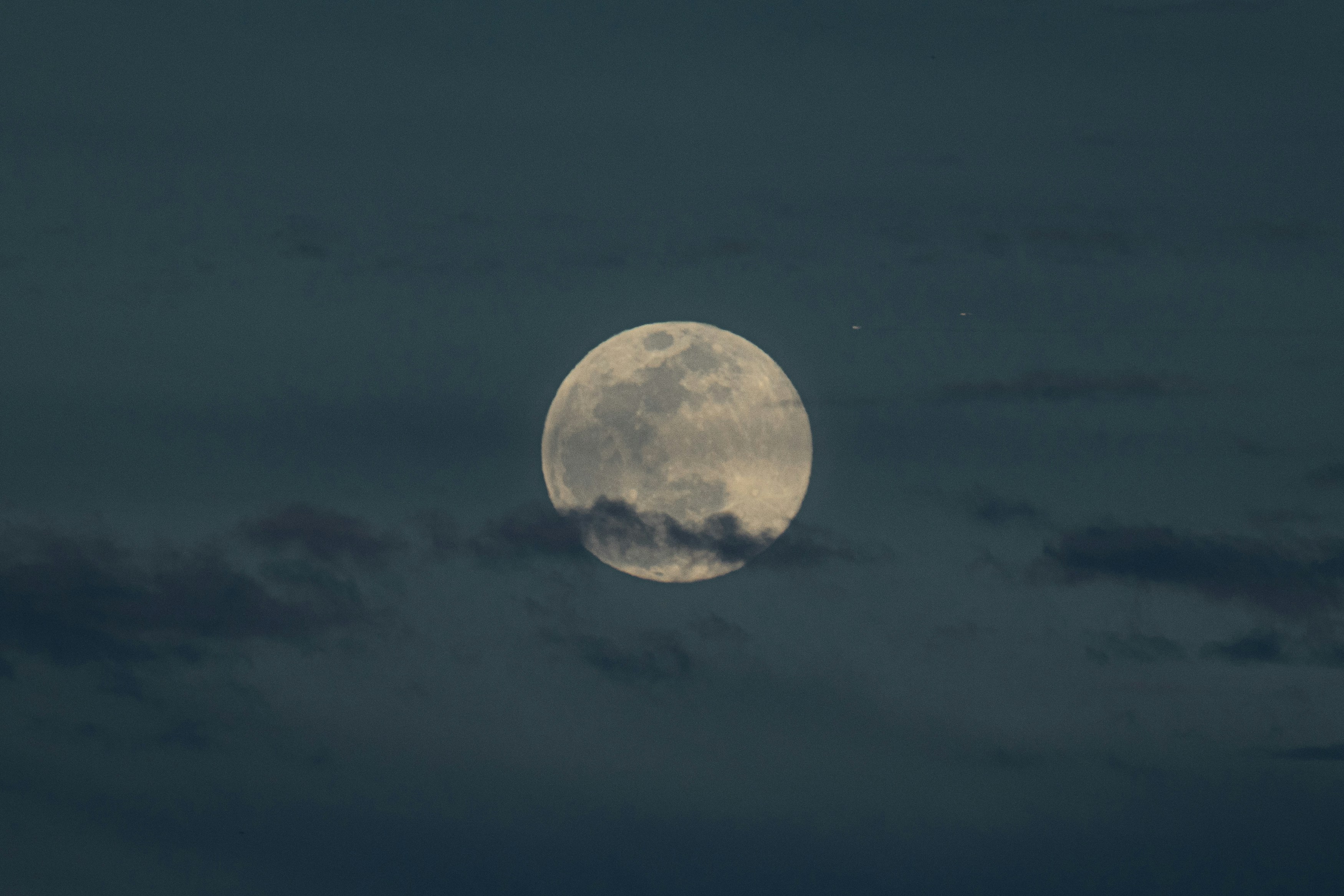 Lunar Glow Amidst Twilight Clouds