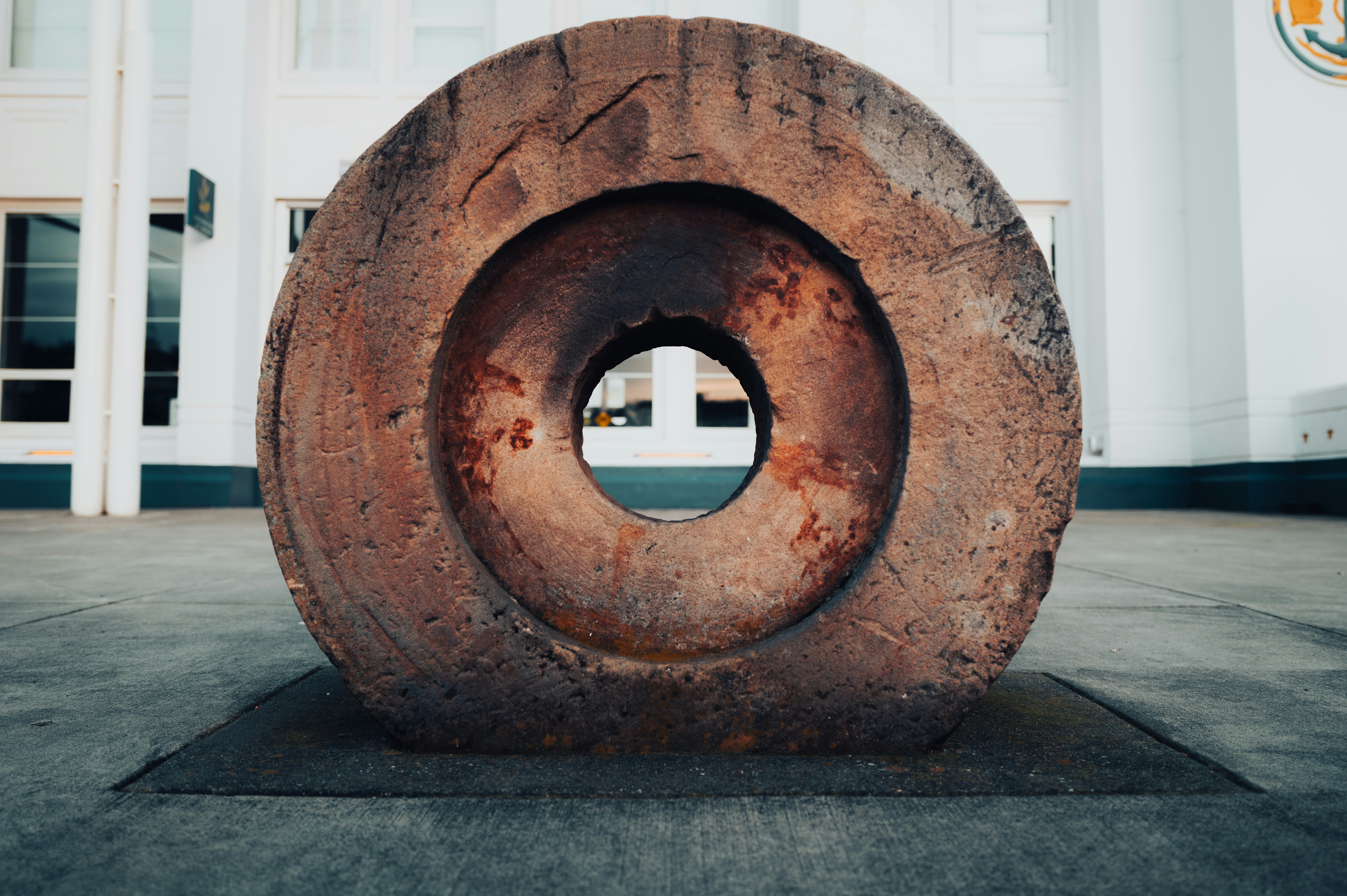 Rusted Ring Portal Framing a Quiet Courtyard