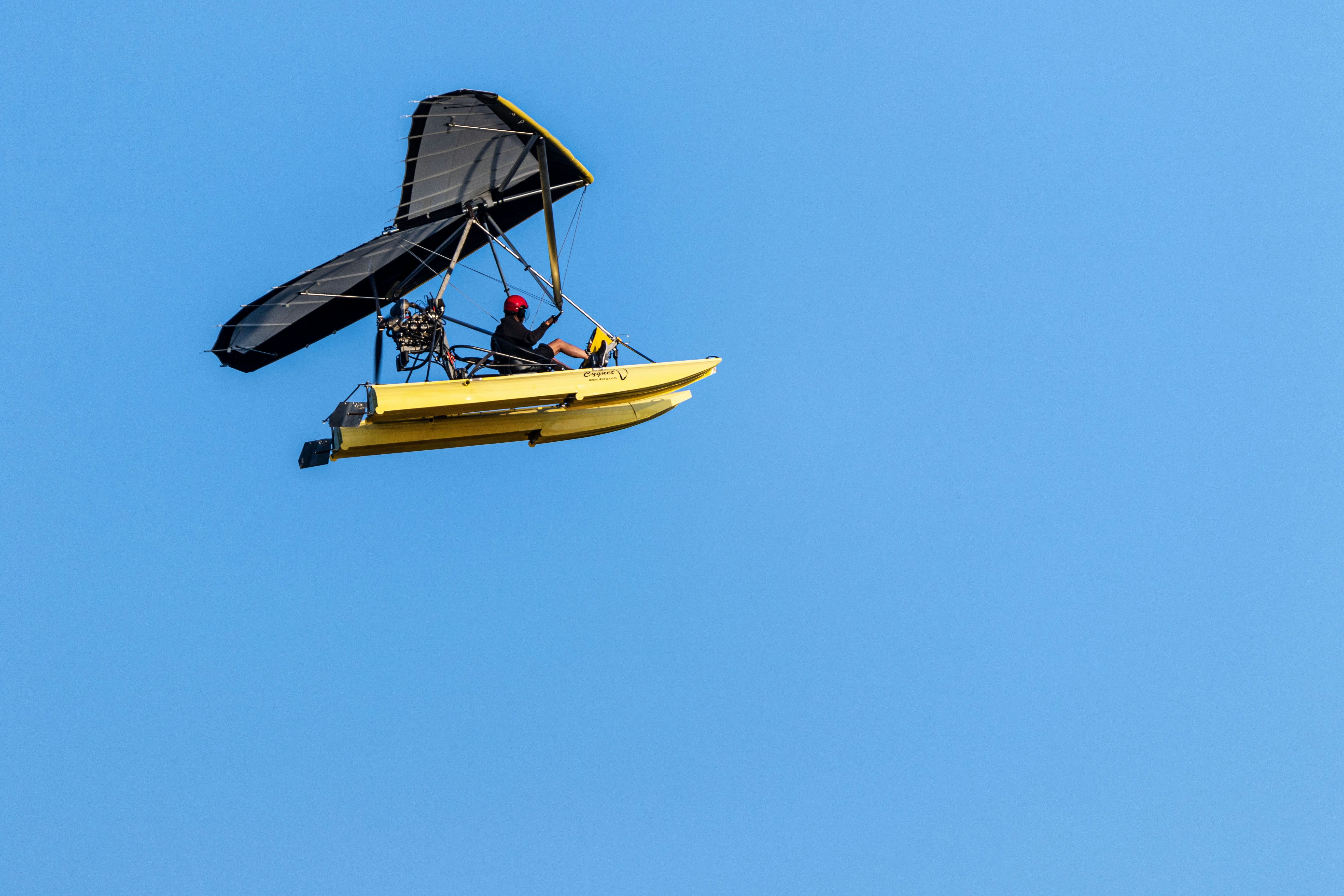 A man is flying a small plane in the sky photo – Free Plane Image on ...