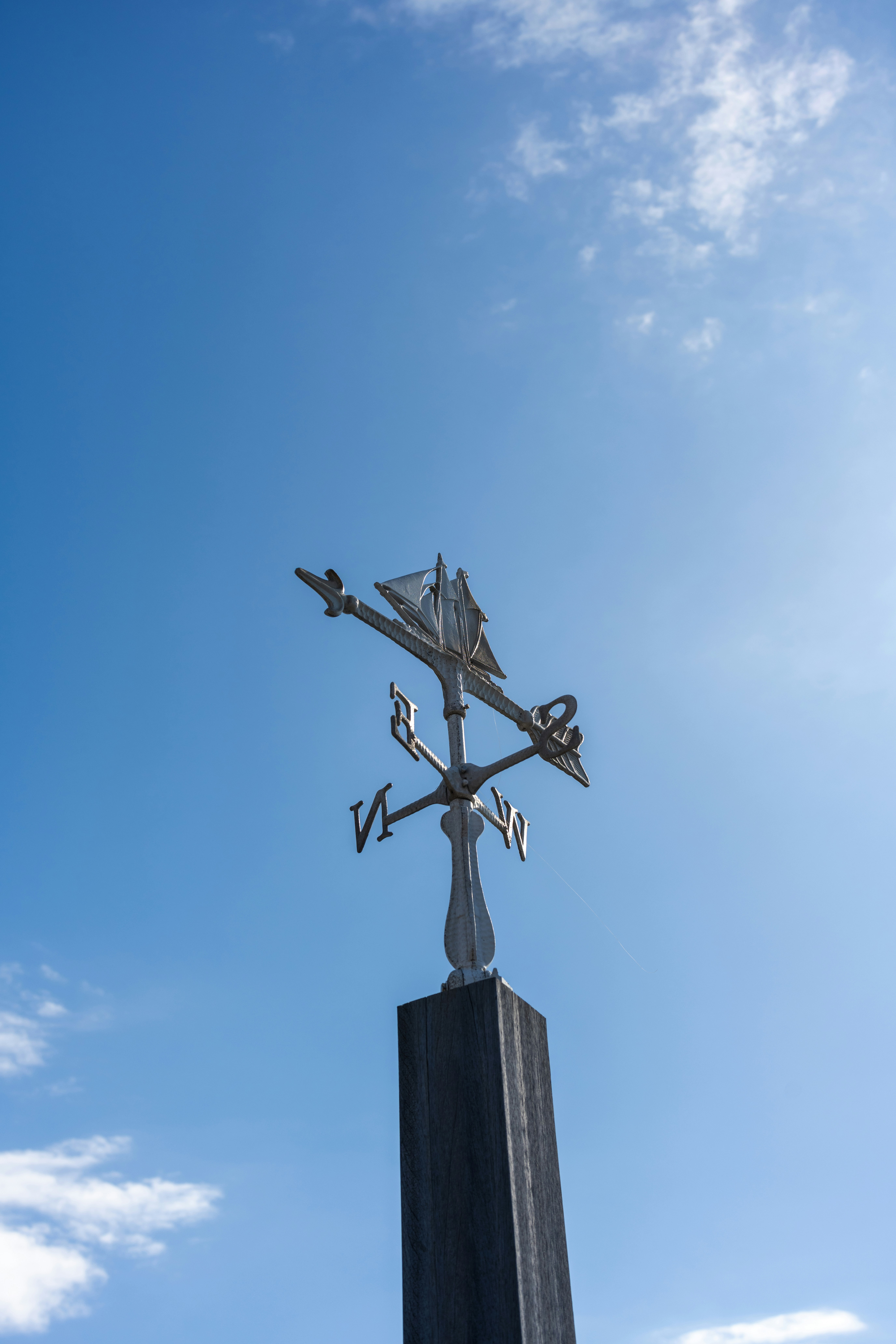 A weather vane on top of a building photo – Free Blue Image on Unsplash
