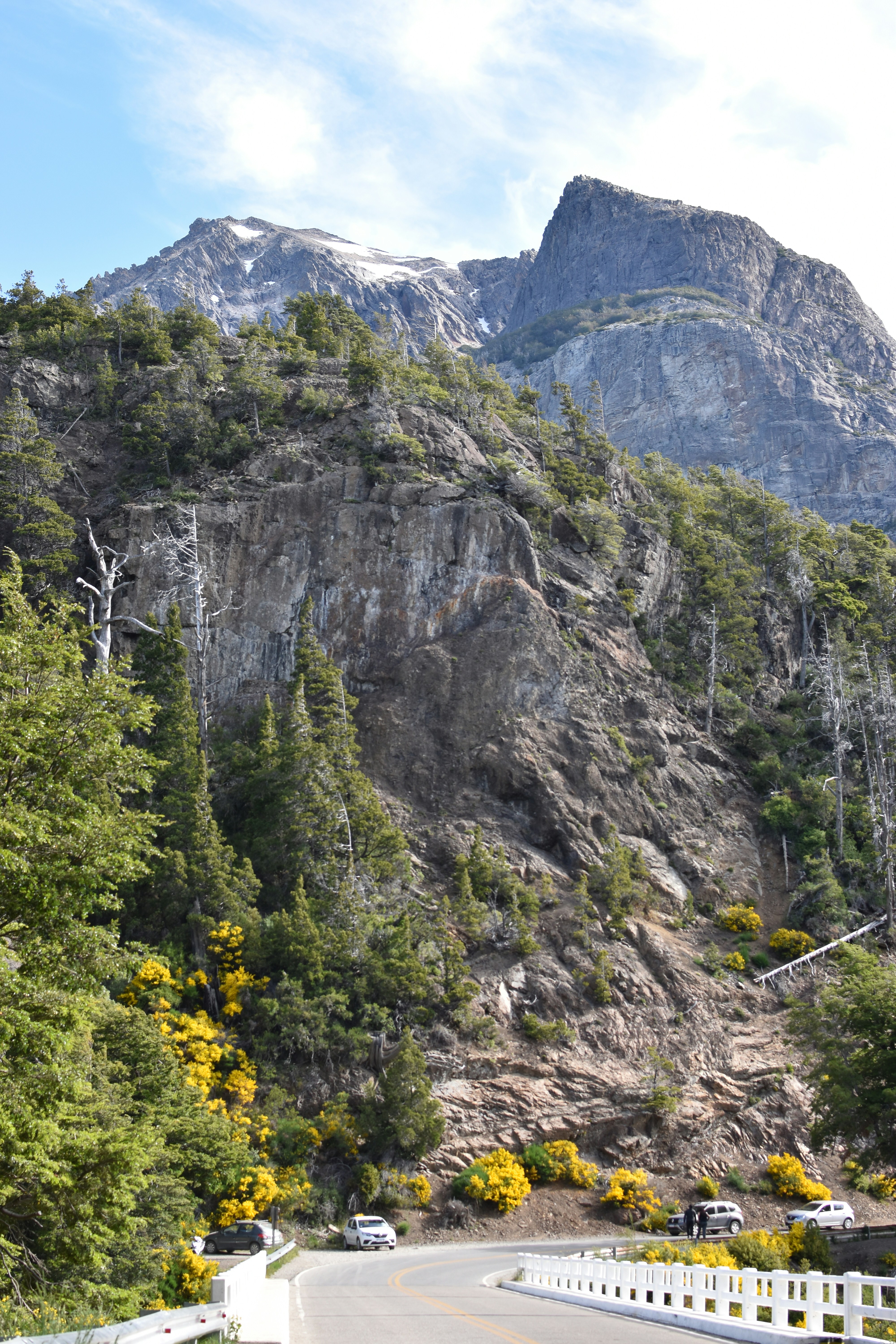 Alpine Ridge: Sunlit Peak Over a Winding Road