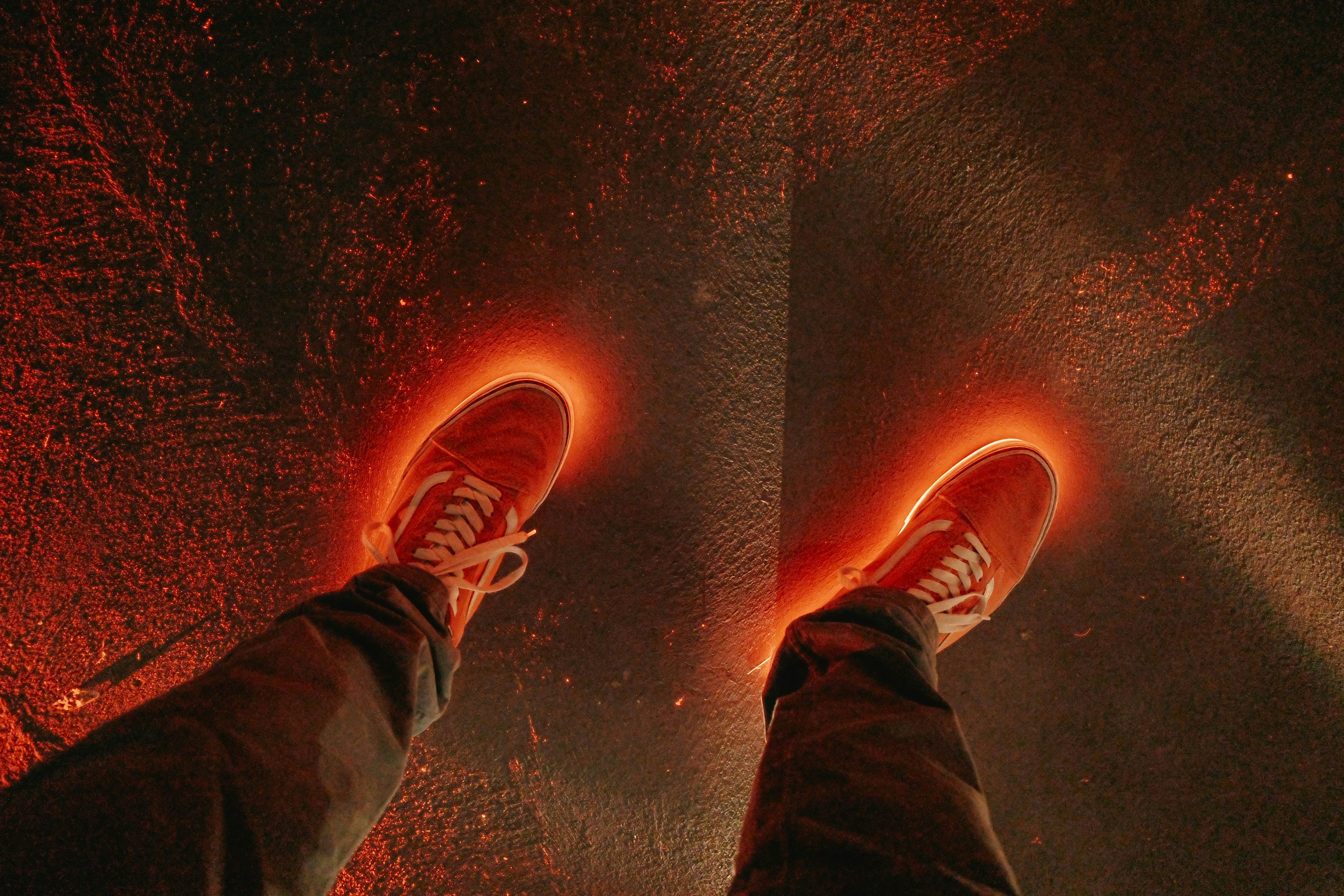 Neon Halo Walk: Top-Down Glow of Red Sneakers