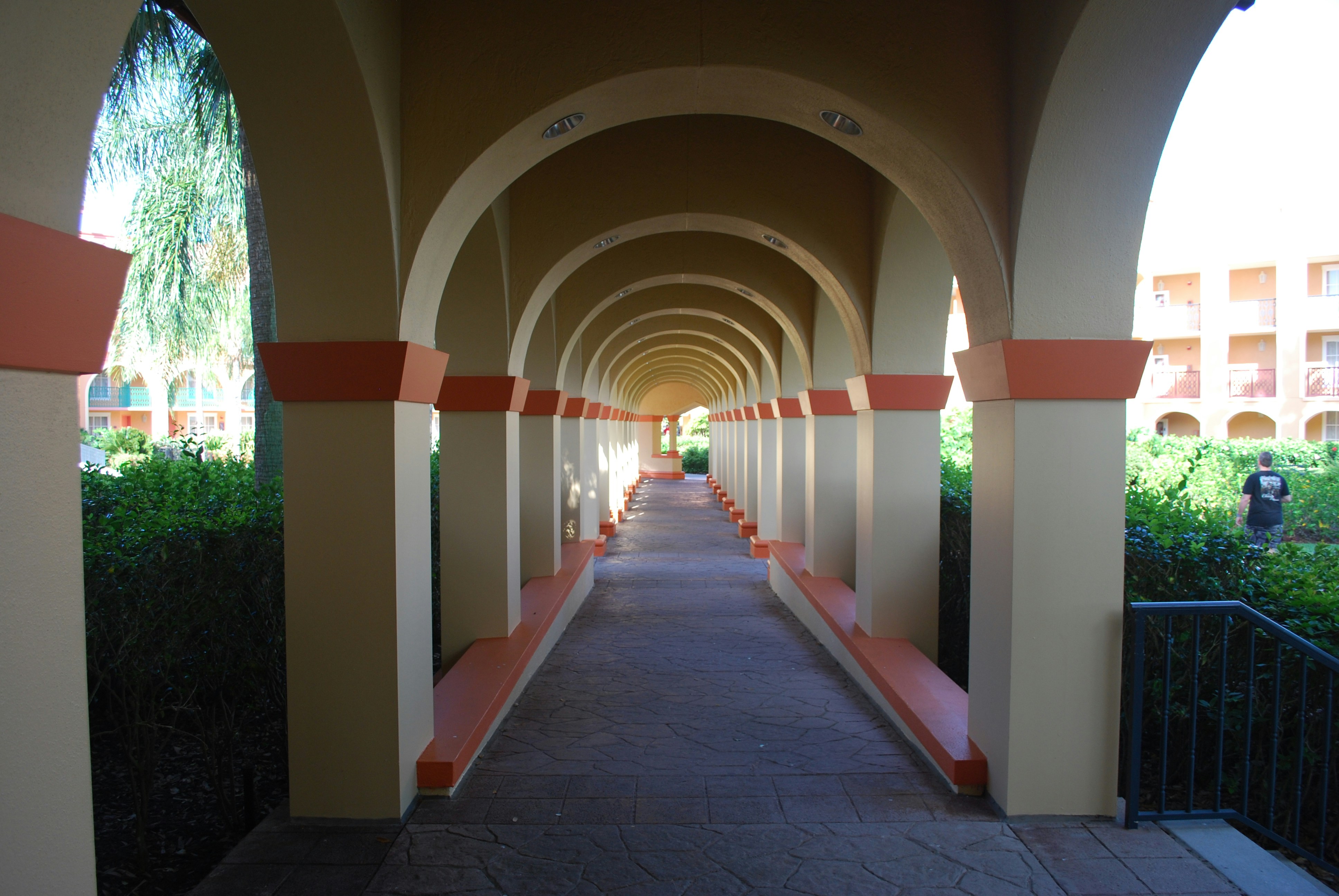 Sunlit Colonnade: A Vanishing Corridor of Arches