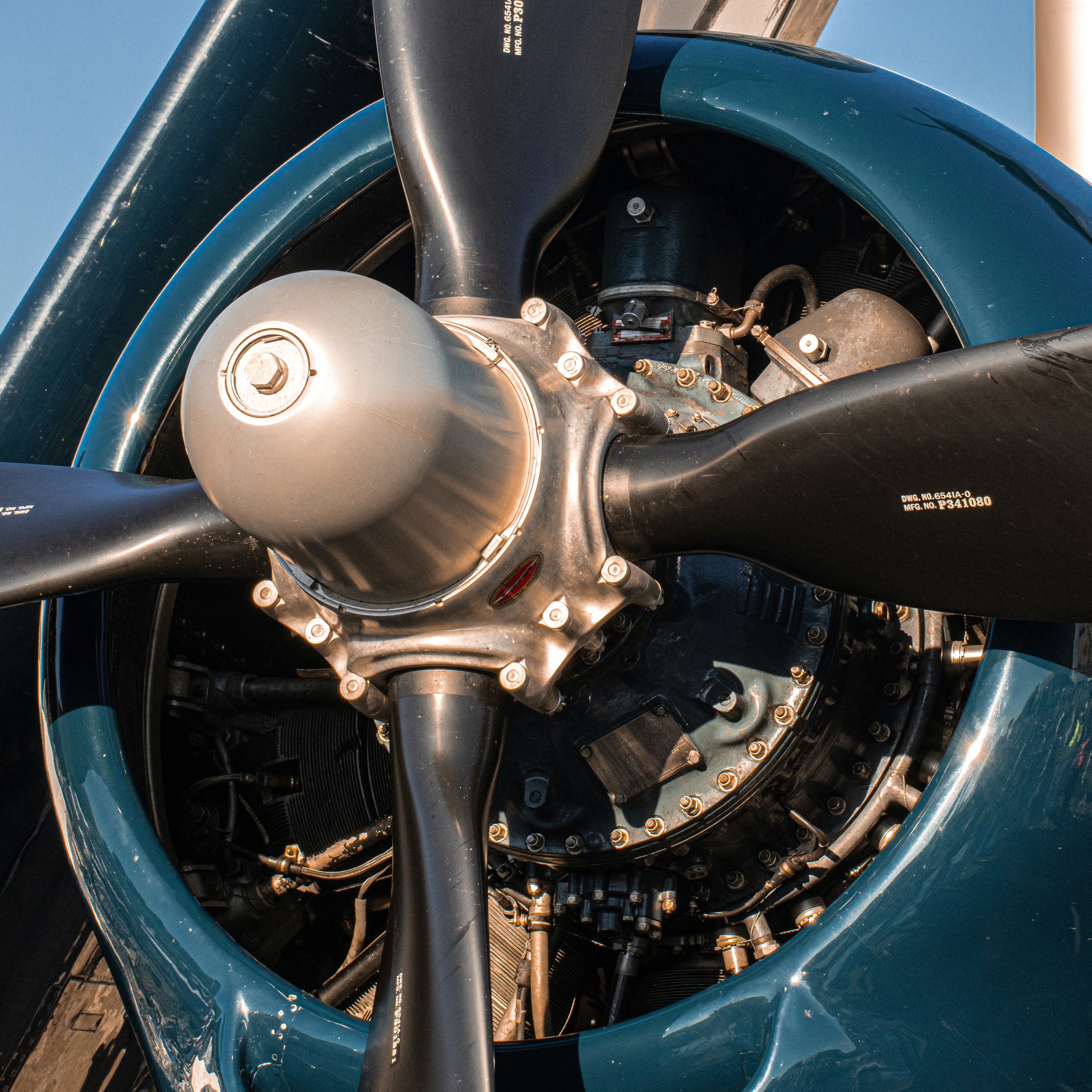 Close-up of a vintage aircraft propeller and engine, showcasing intricate mechanical details and craftsmanship.