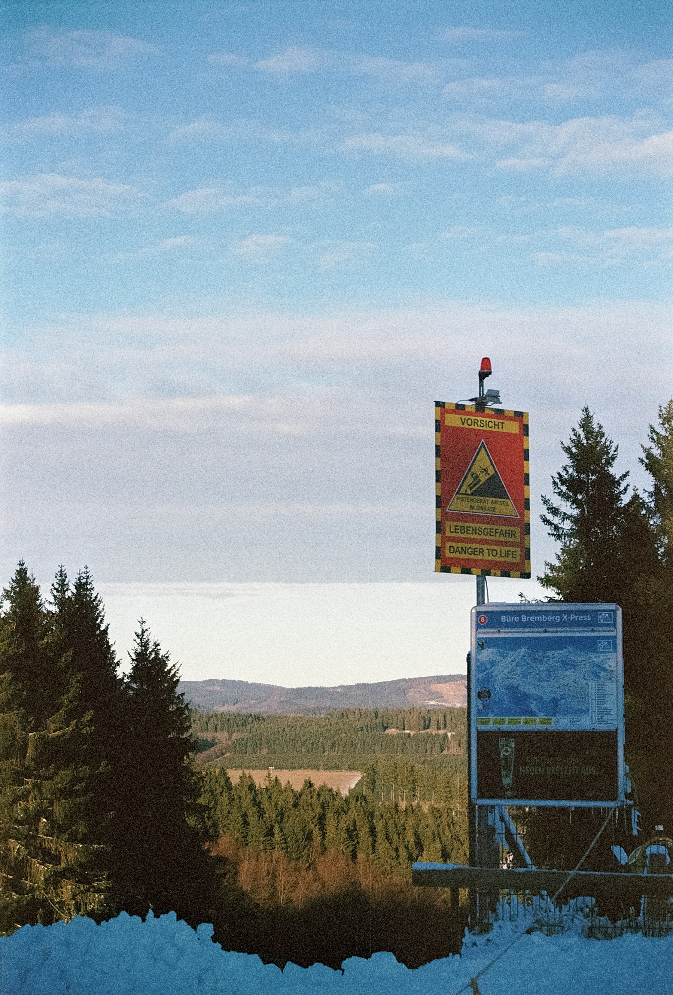 Red-Triangle Warning Sign Over Snowy Alpine Vista