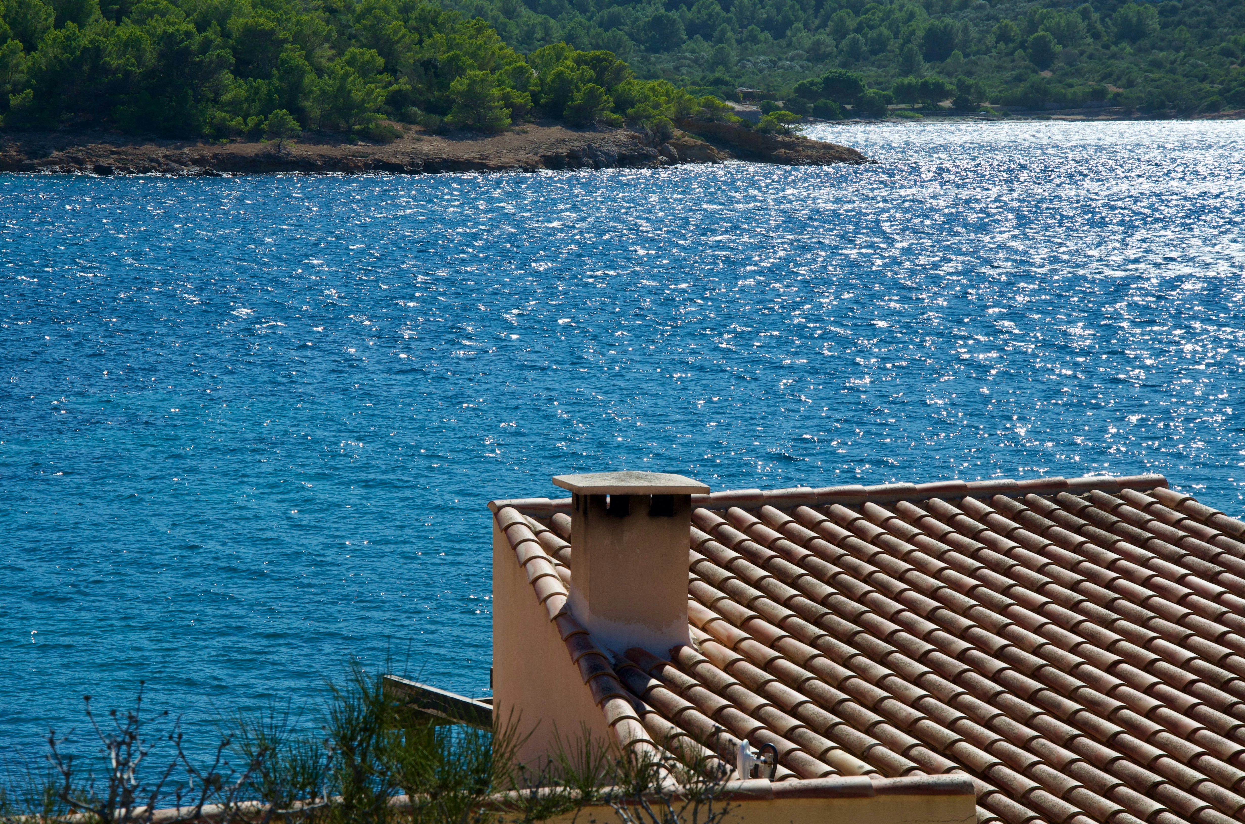 Terracotta Roofline Framing a Sapphire Sea