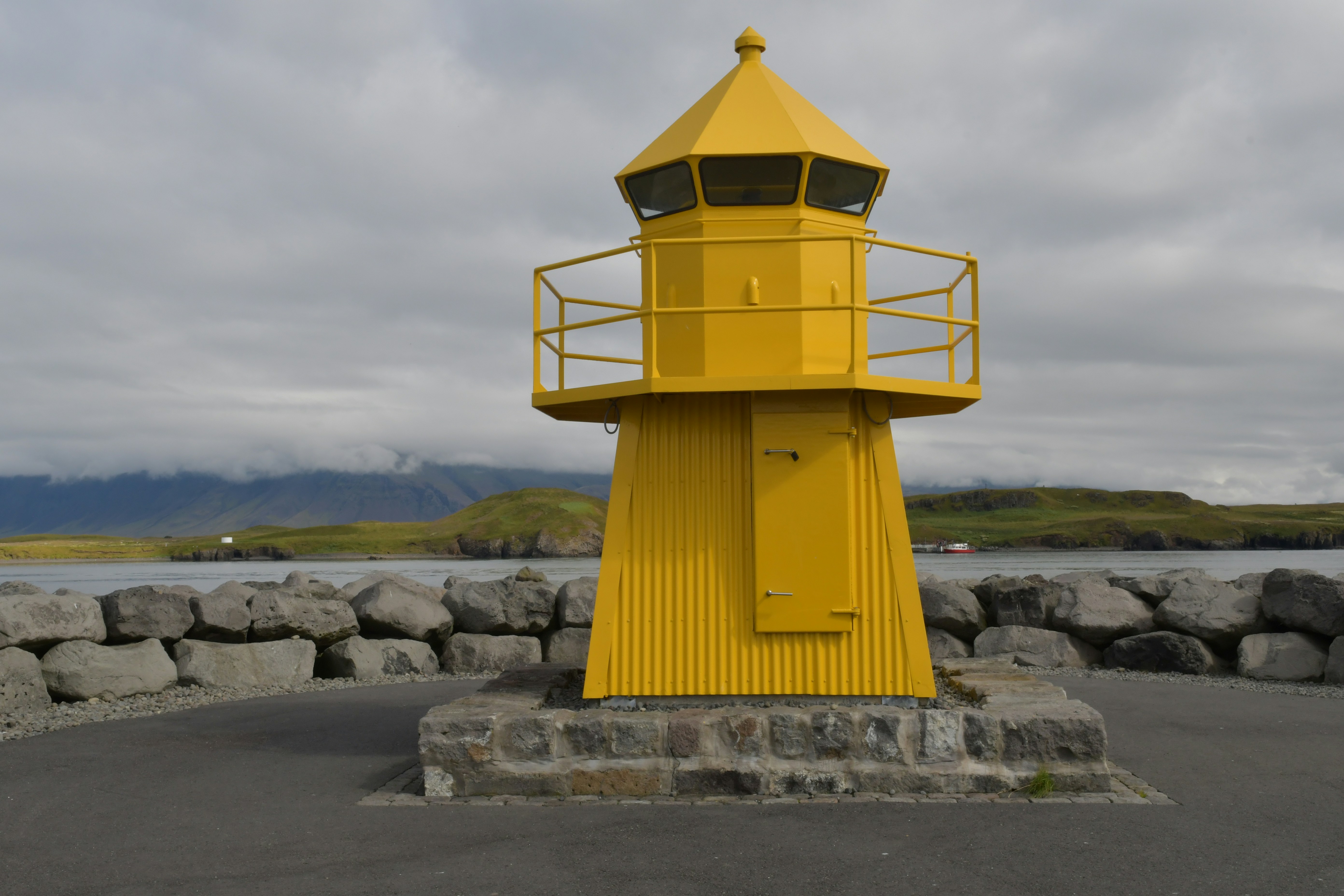 Yellow Beacon at the Breakwater: A solitary lighthouse amid a stormy coast