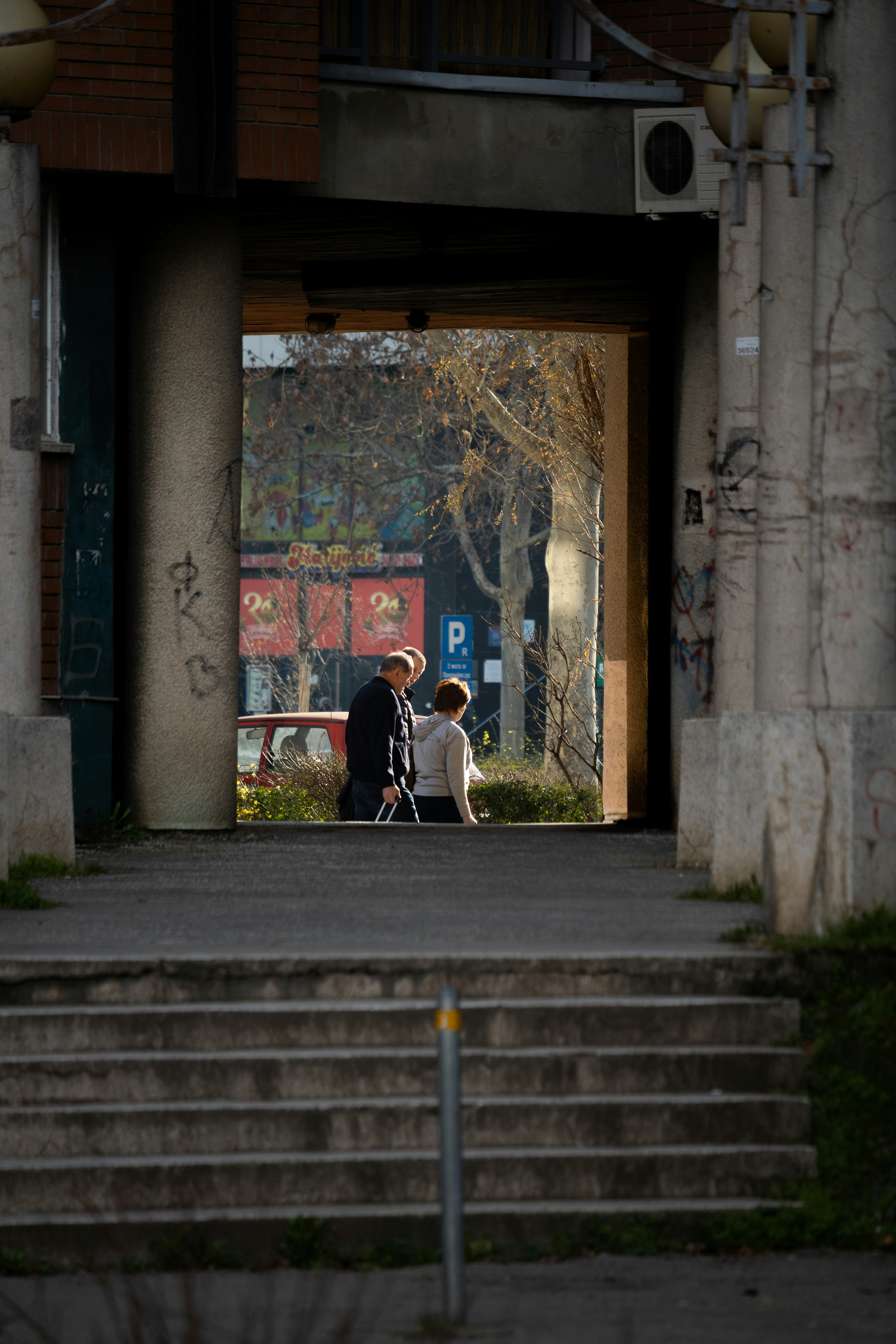 Two Figures in a Framed Street Corridor