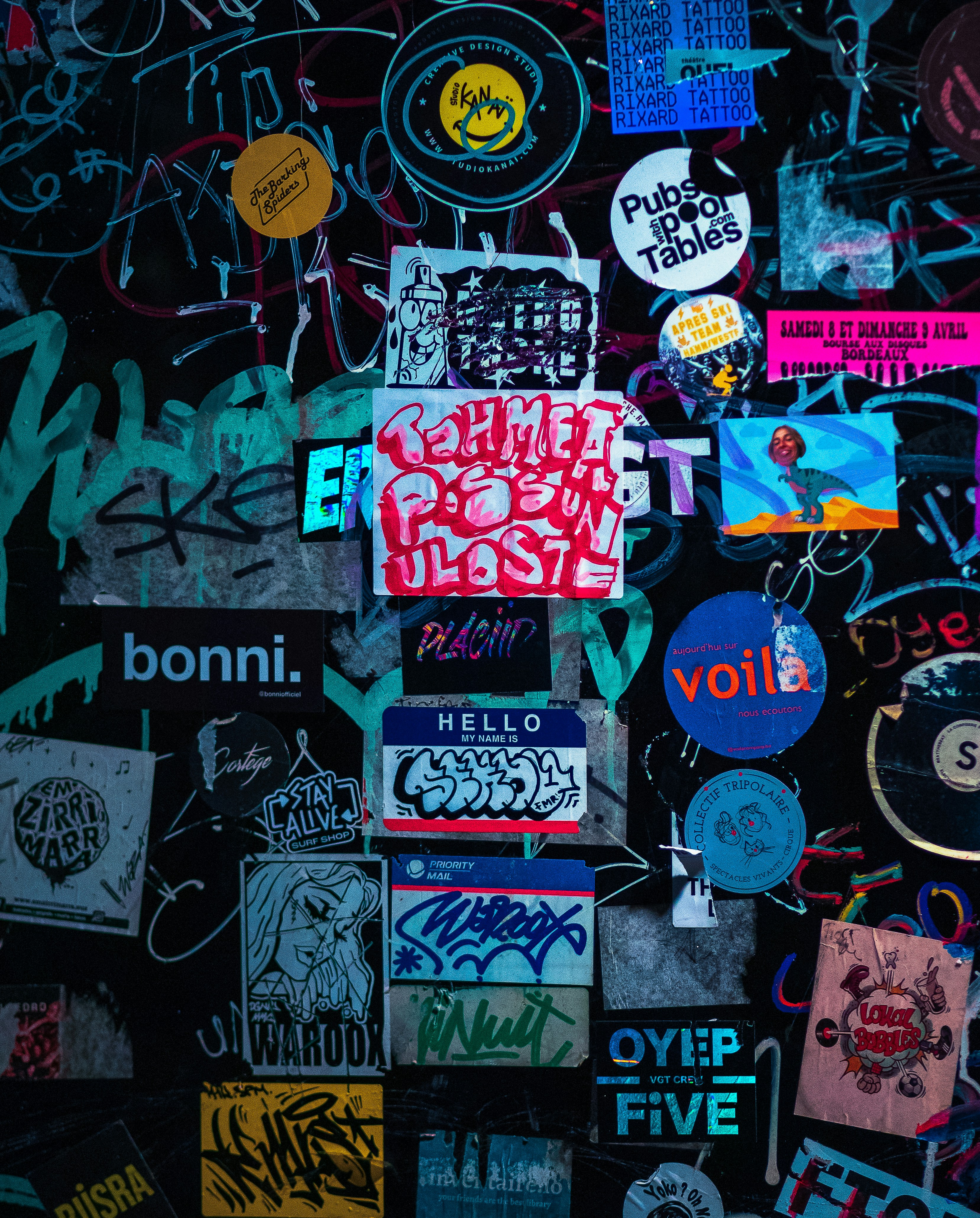A wall covered in lots of different types of stickers photo – Free Wall ...