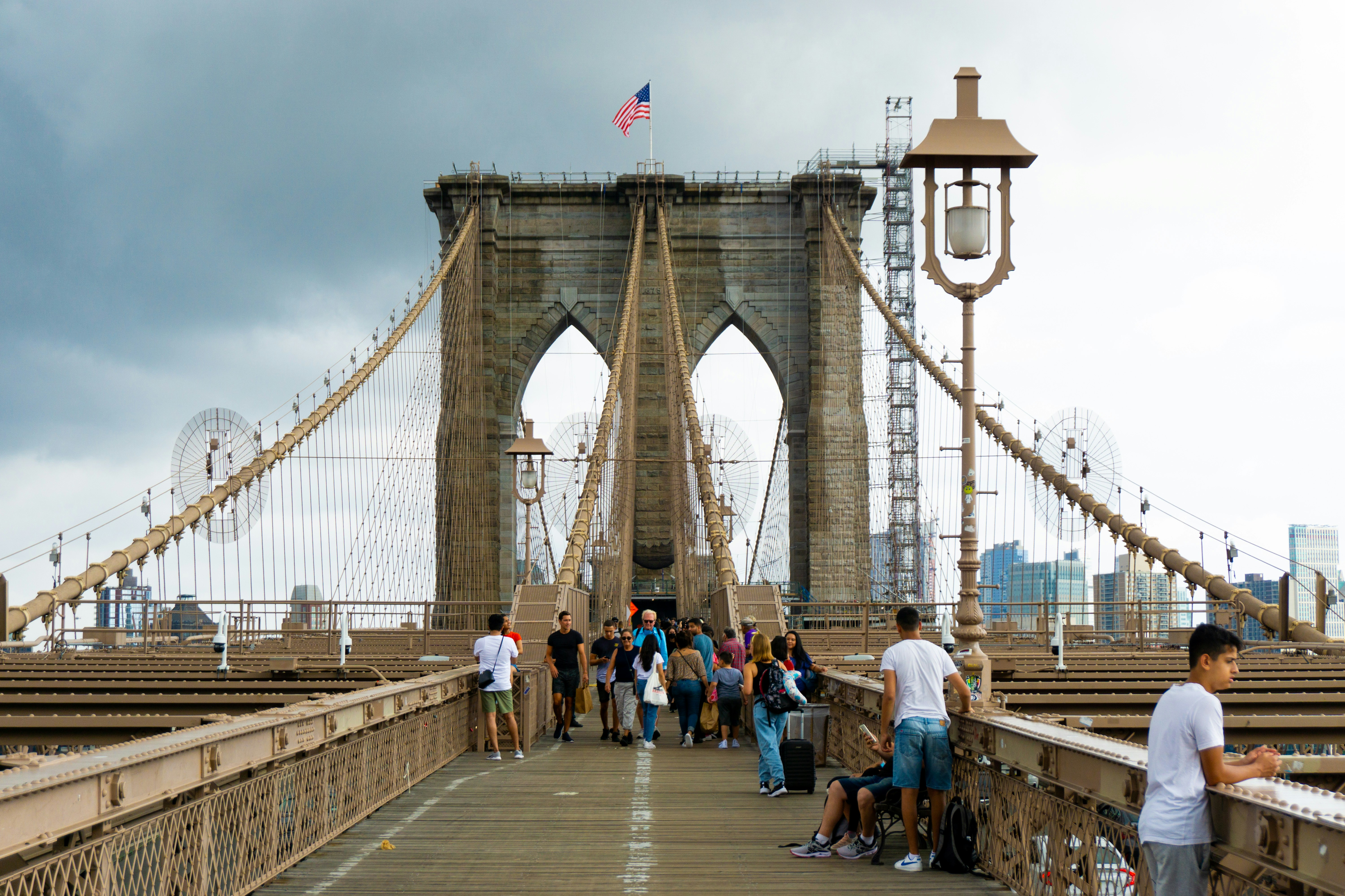 A group of people walking across a bridge photo – Free Brooklyn bridge ...