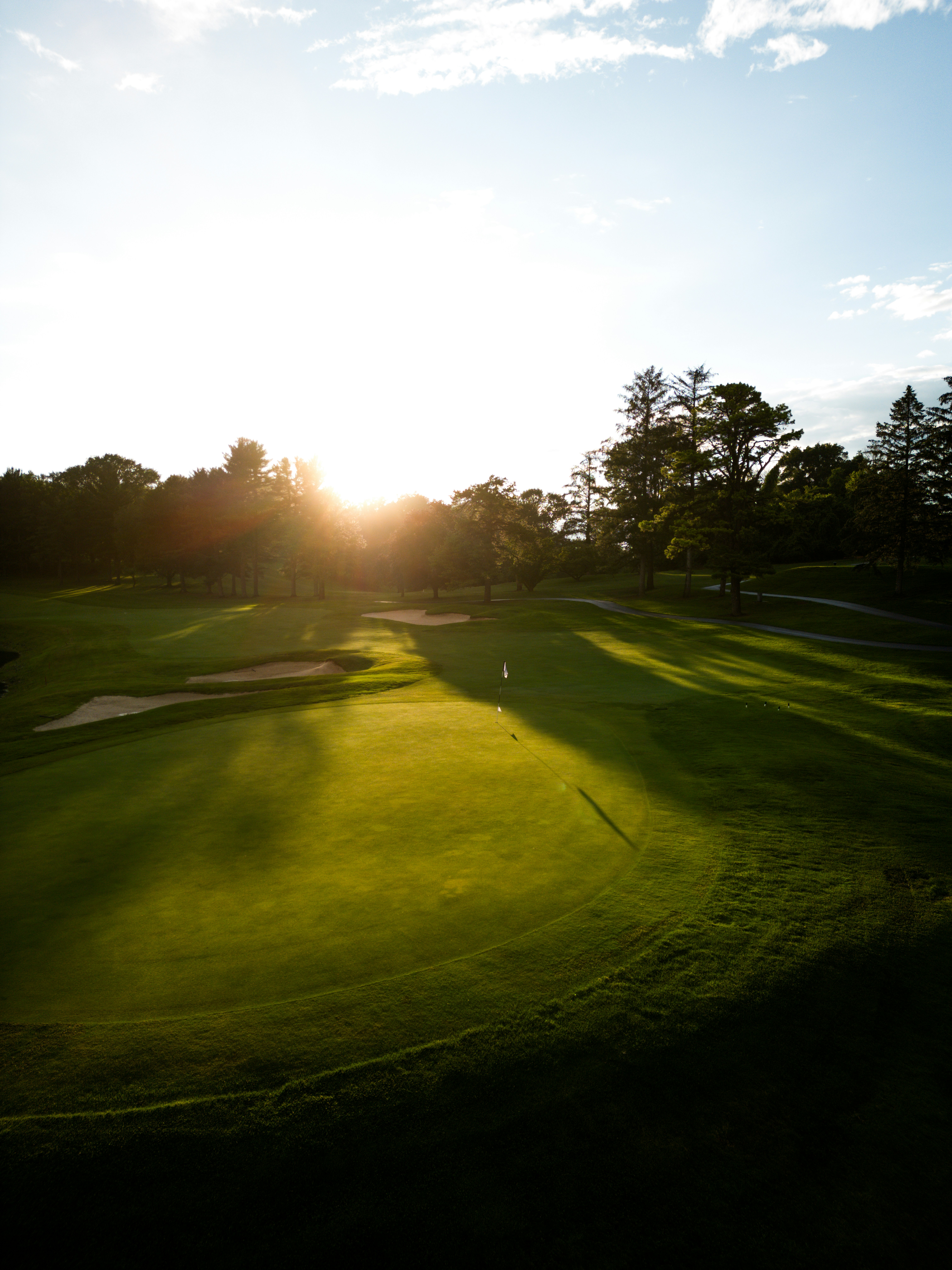 The sun is setting on a golf course photo – Free Meadia heights golf ...