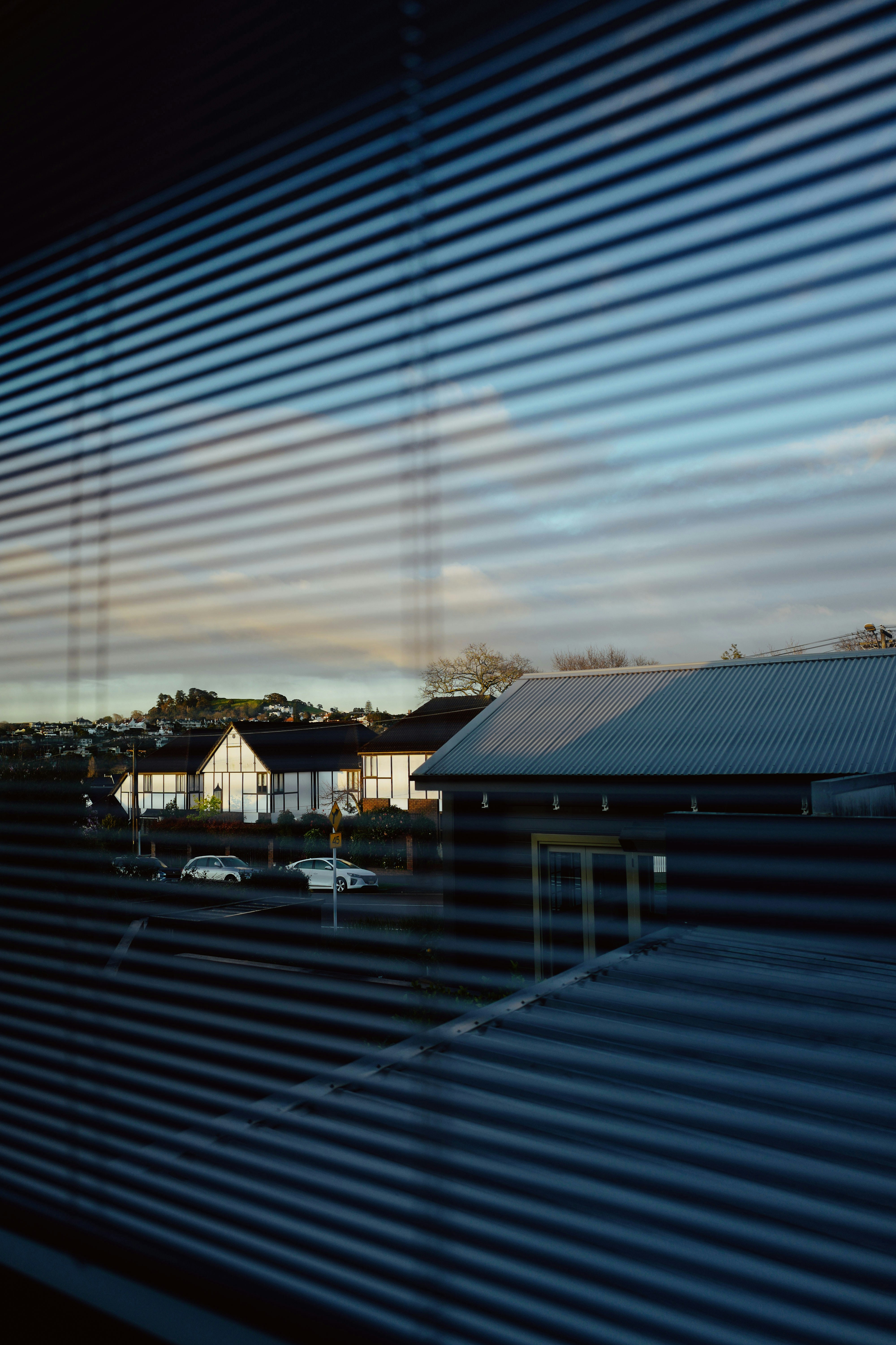 A view of a parking lot through a window photo – Free Grey Image on ...