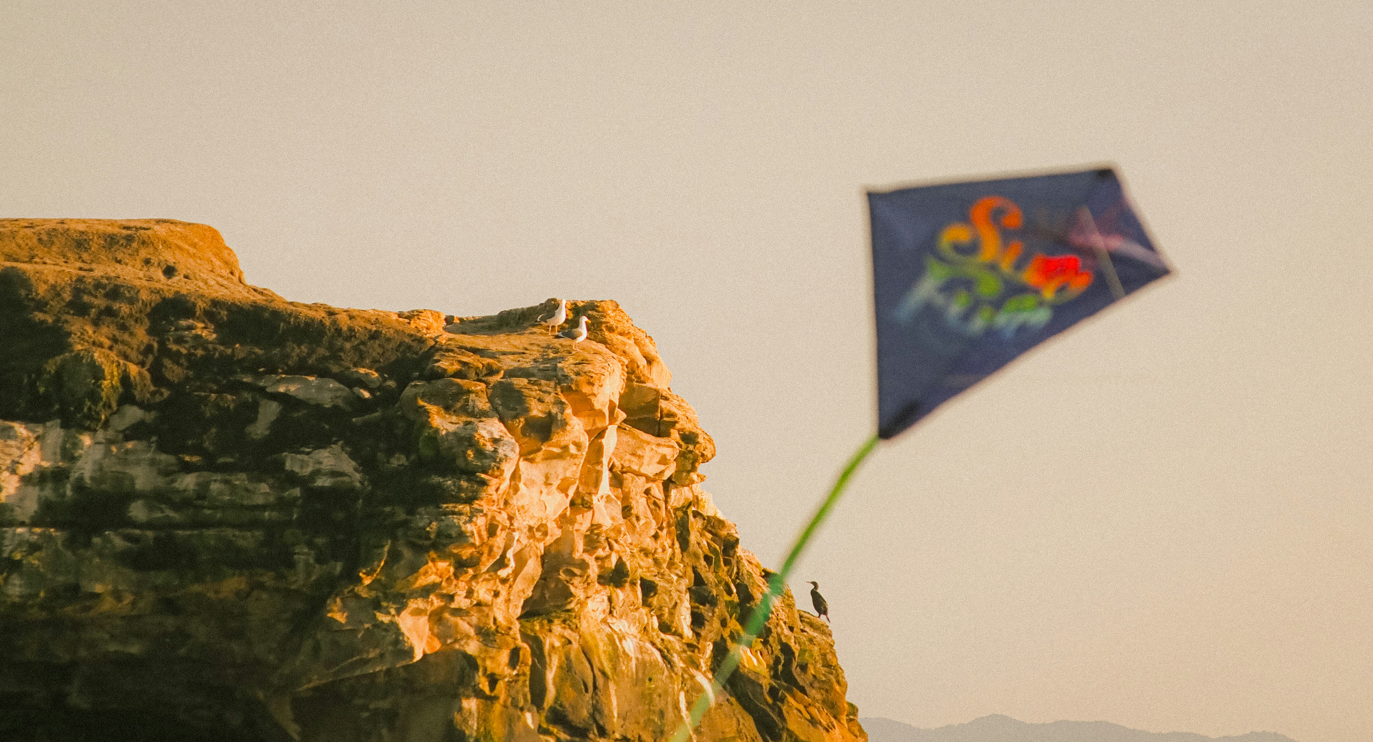 Kite Above the Cliff: A Distant Freestyle Moment