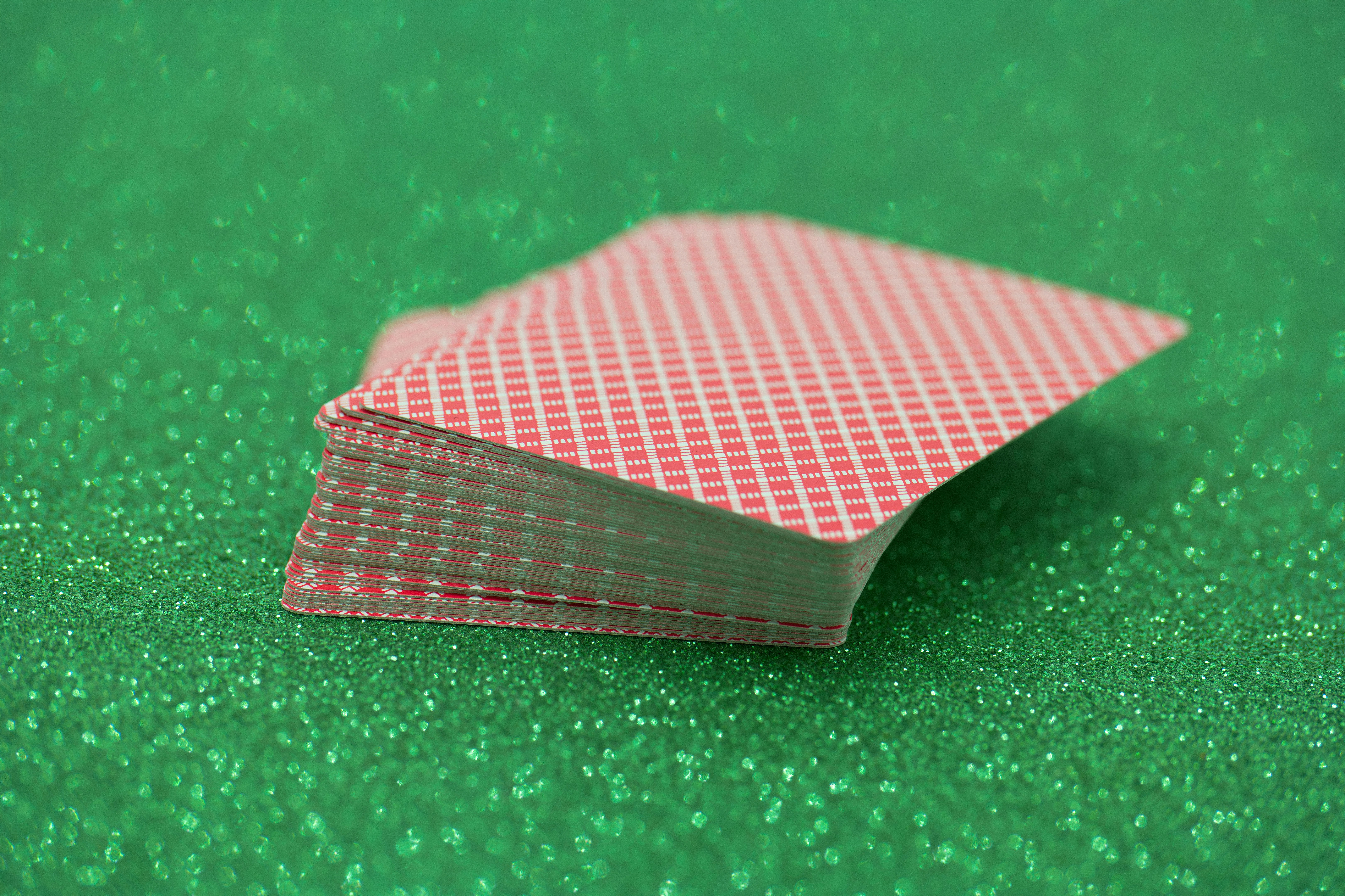 A red and white checkered card on a green surface photo – Free Paper ...