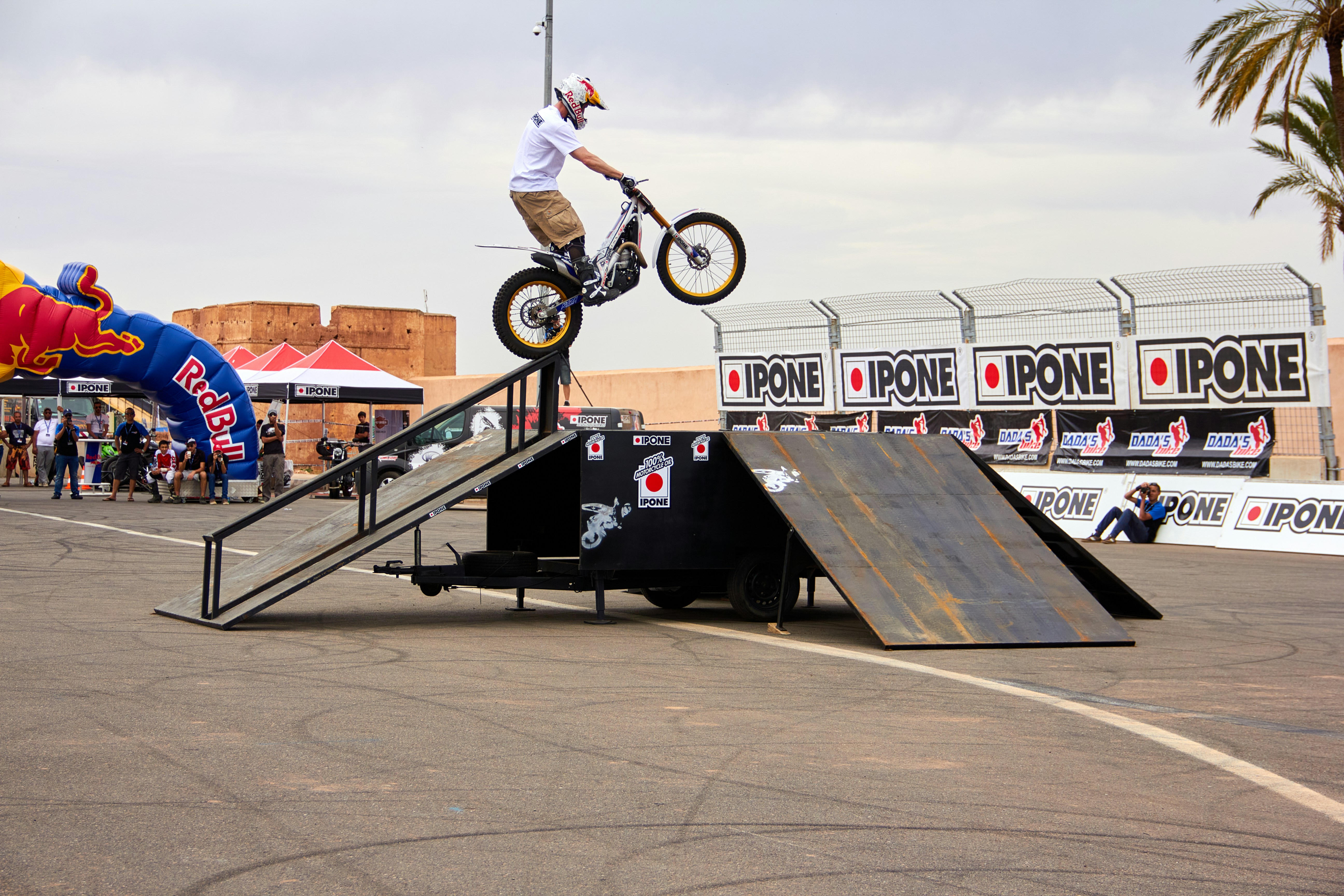 A man on a motorcycle jumping over a ramp photo – Free Festival Image ...